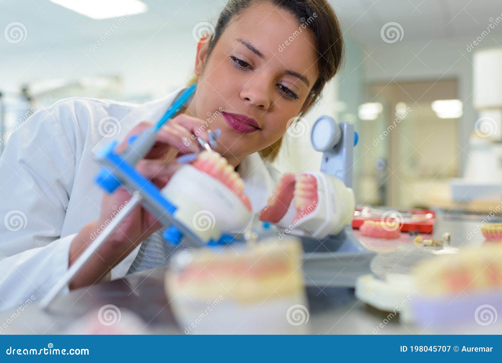Dental technician at work stock image. Image of bite - 198045707