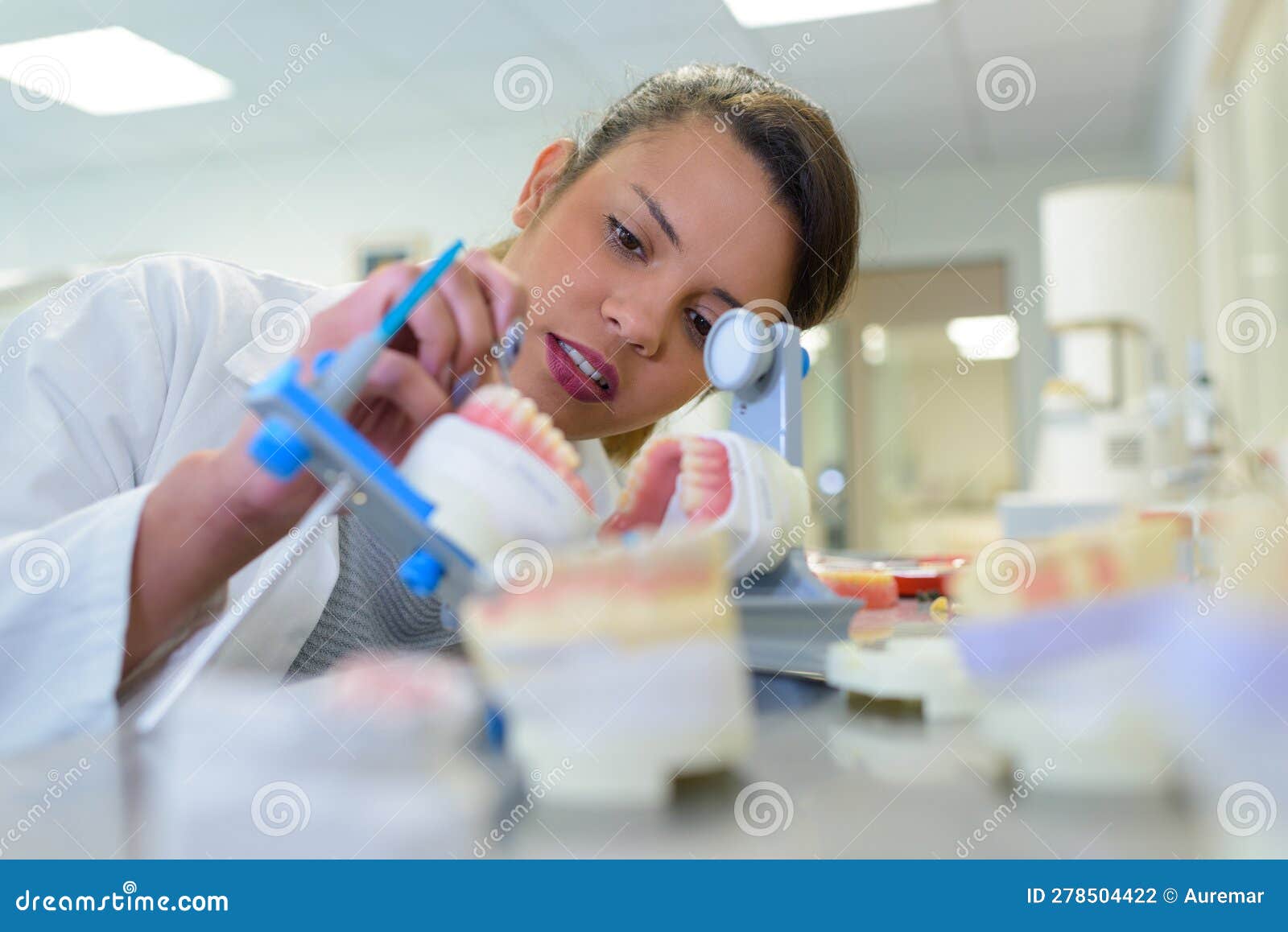 Dental Technician Working in Laboratory Preparing False Teeth Stock ...