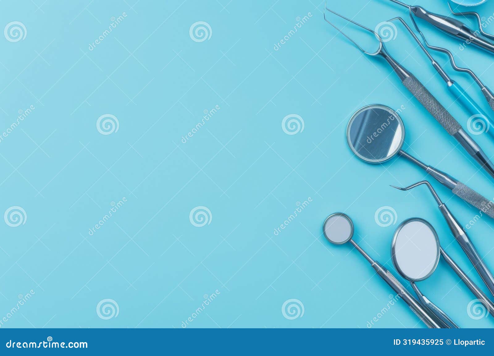 Dental Tools and a Model of Teeth Displayed on a Light Blue Background ...