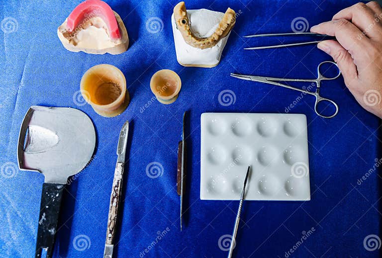Dental Tools and Prosthetic Molds on a Blue Workspace Stock Image ...