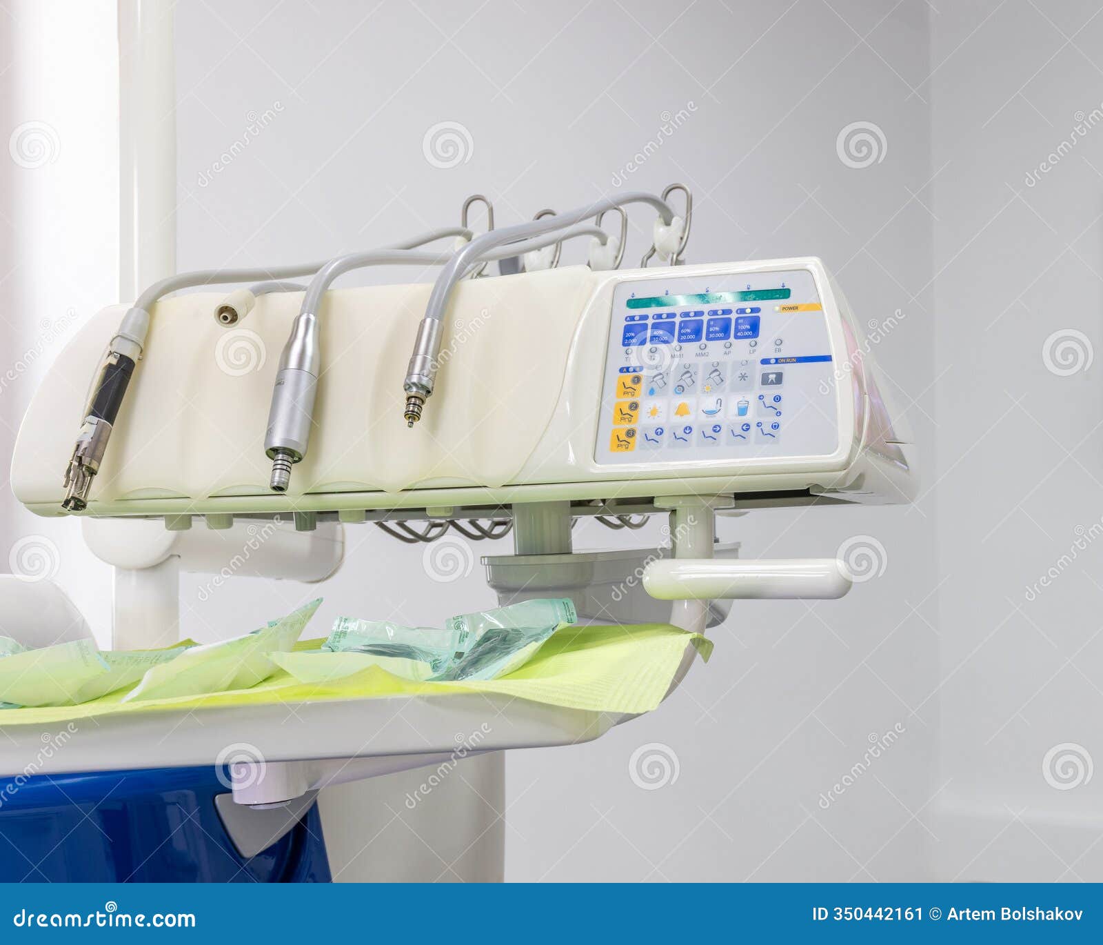 Dental Unit Featuring Handpieces, a Control Panel, and Neatly Arranged ...