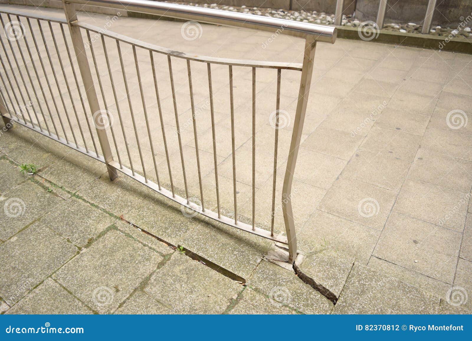Dented Silver Railing on the Pavement Stock Photo - Image of railing ...