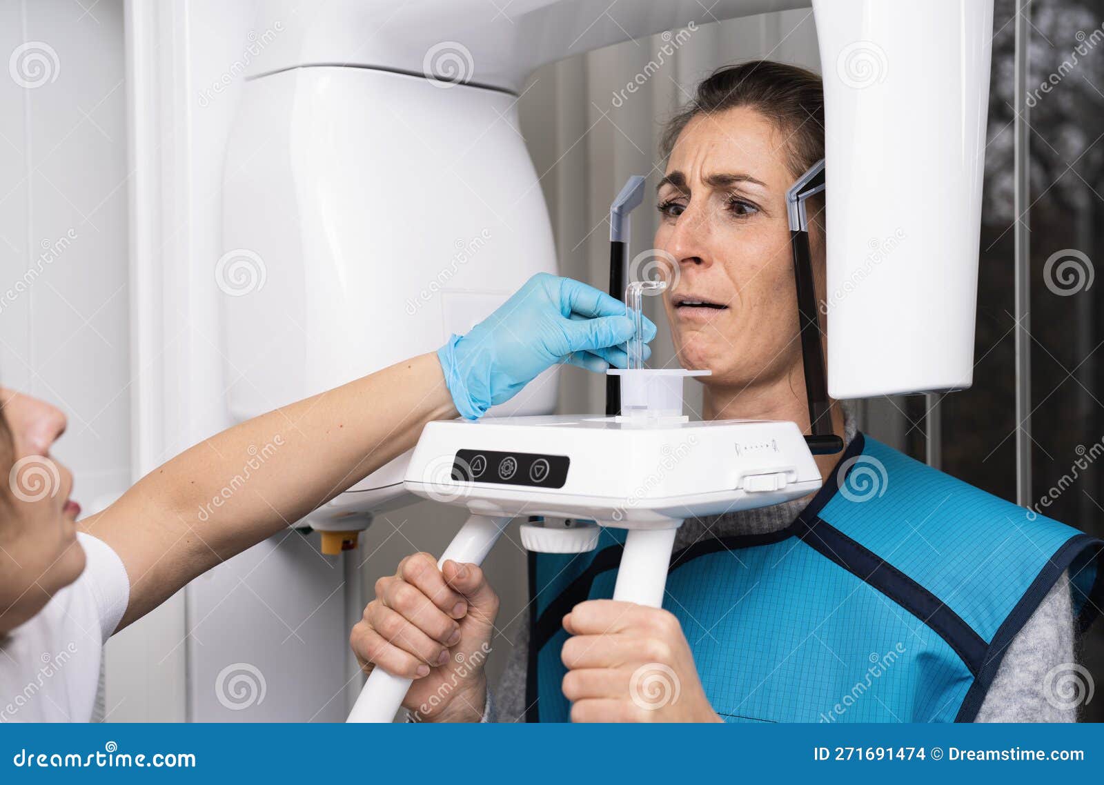 Dentist Adjusts X-ray Machine Towards a Skeptical Patient. Panoramic ...