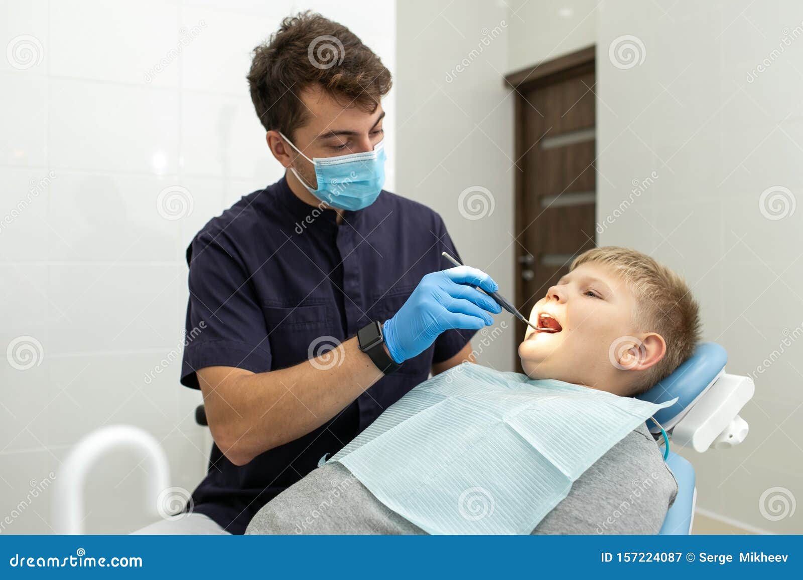 Dentist in Clinic Examines Teeths of Young Boy Stock Image - Image of ...