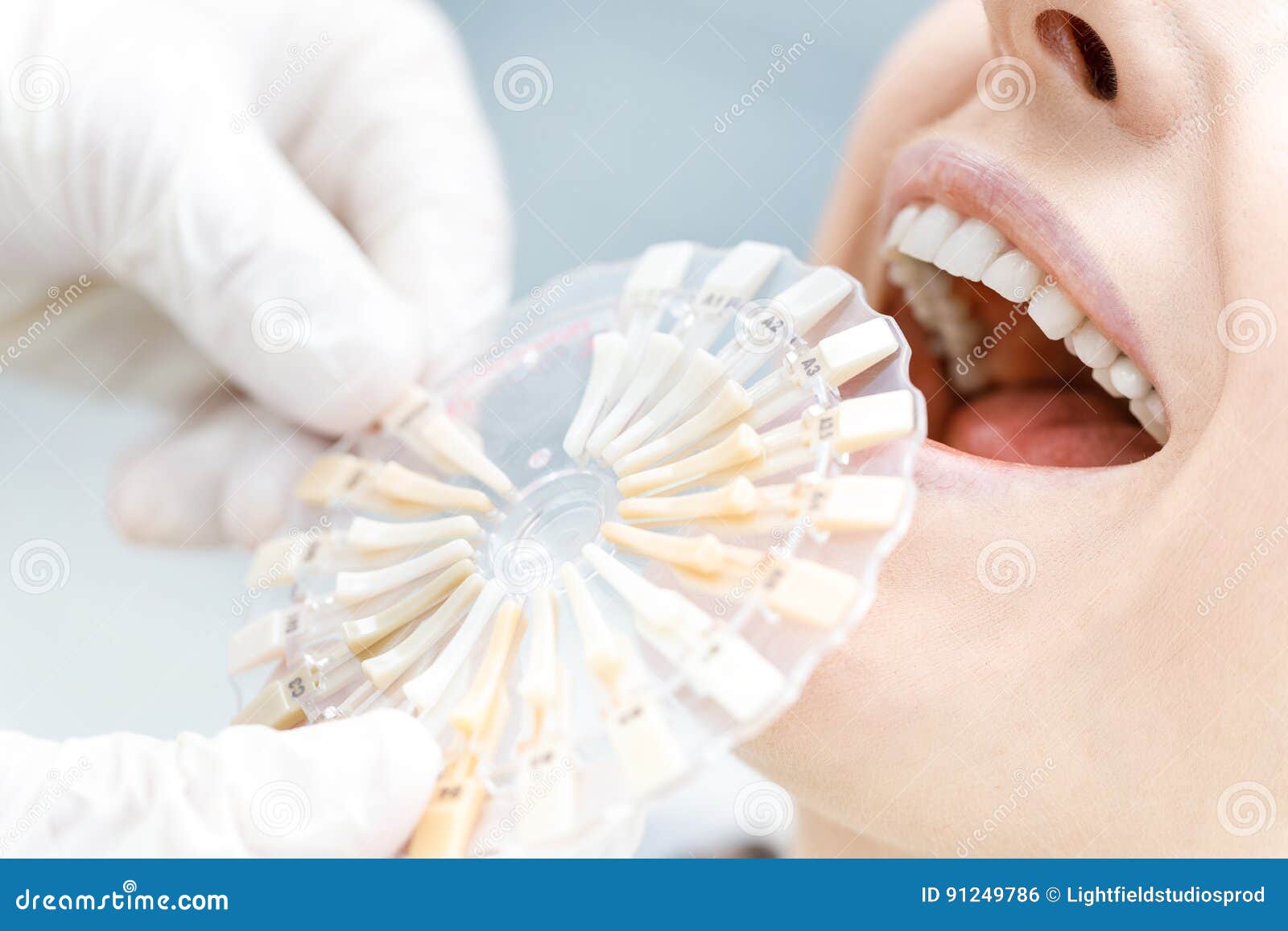 Dentist Comparing Teeth of Patient with Samples Stock Photo - Image of ...