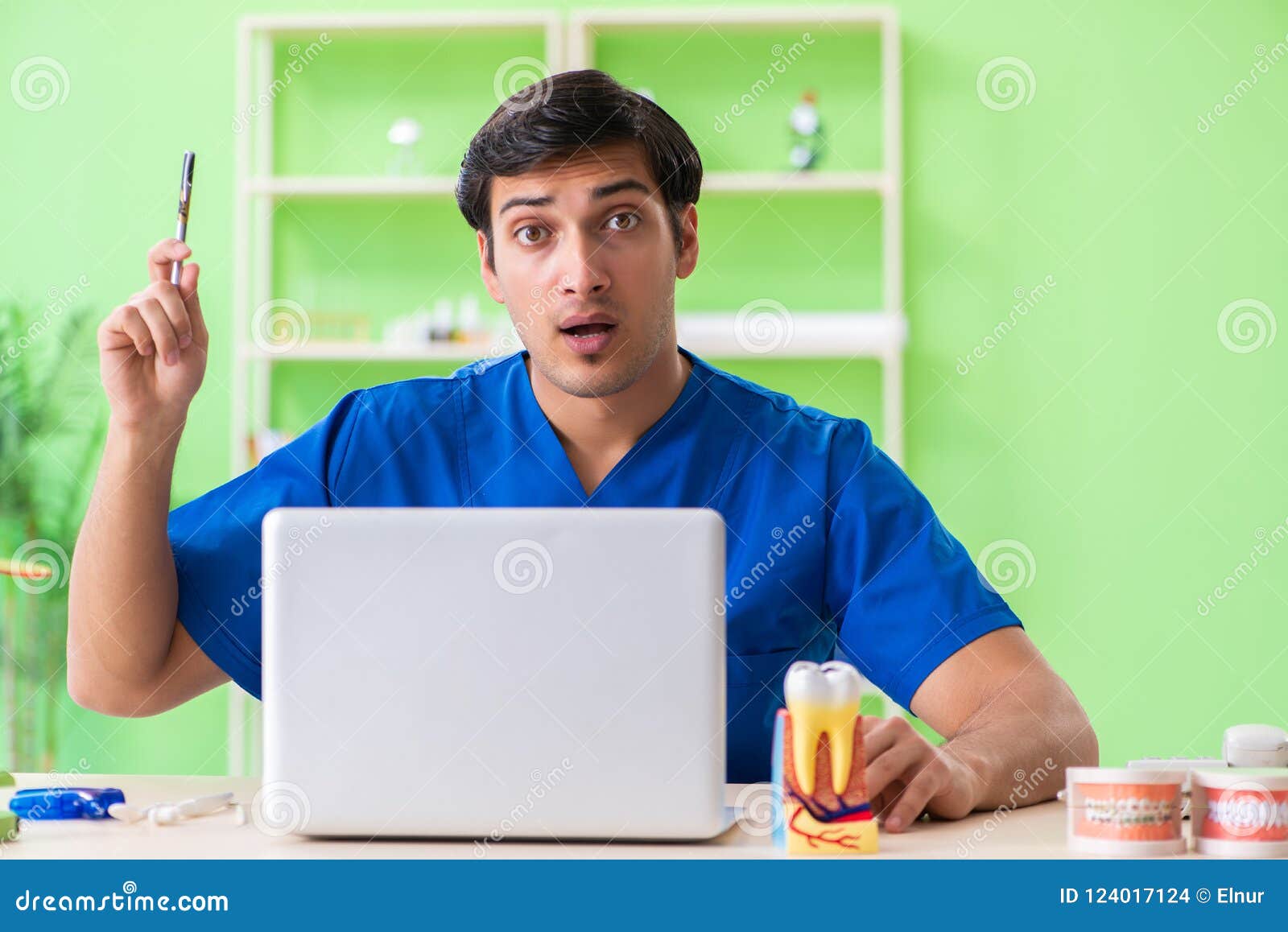 The Dentist Doctor Sitting at Computer in the Clinic Stock Photo ...