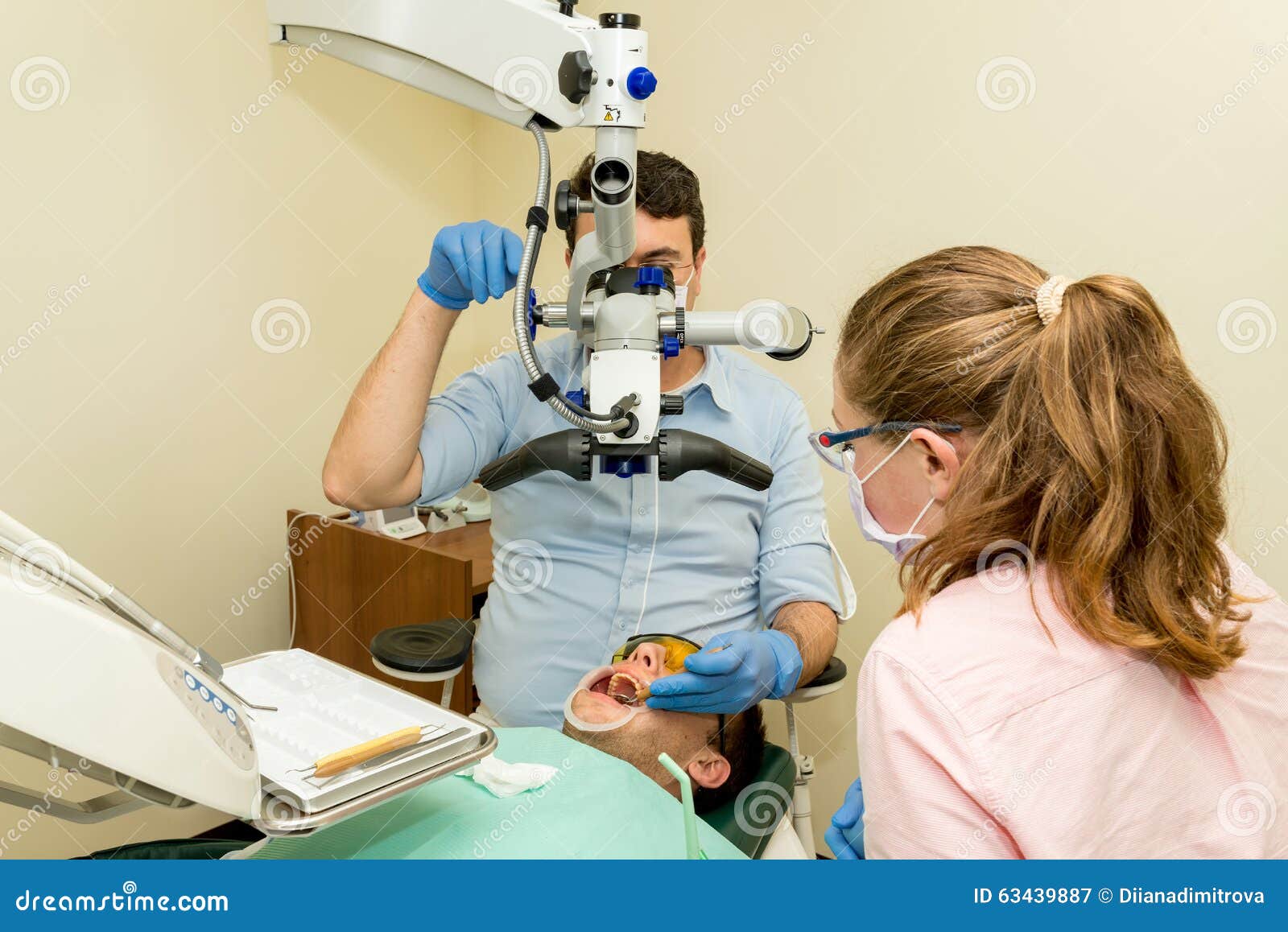Dentist Doing a Dental Treatment Using Microscope Stock Image - Image ...