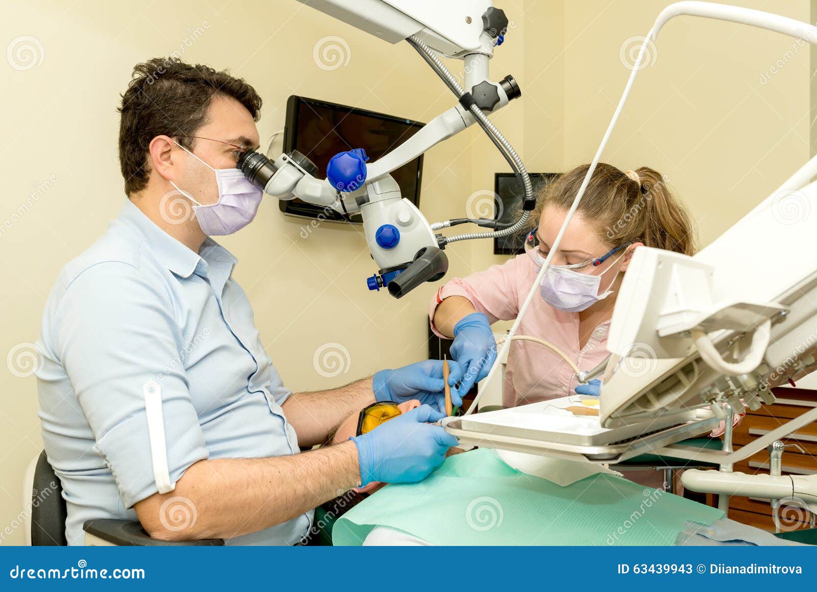 Dentist Doing a Dental Treatment Using Microscope Stock Image - Image ...