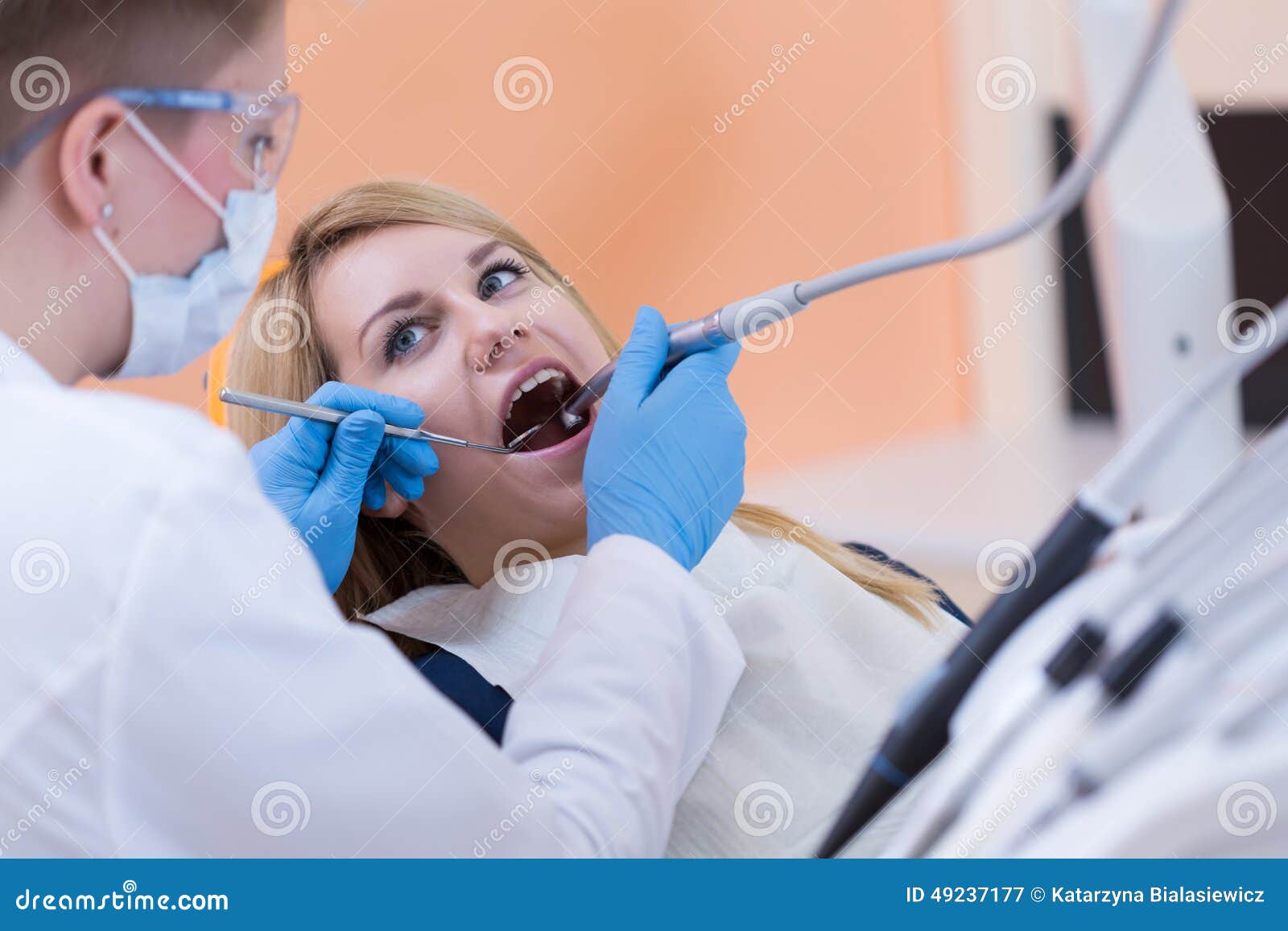 Dentist drilling a tooth stock image. Image of apron - 49237177