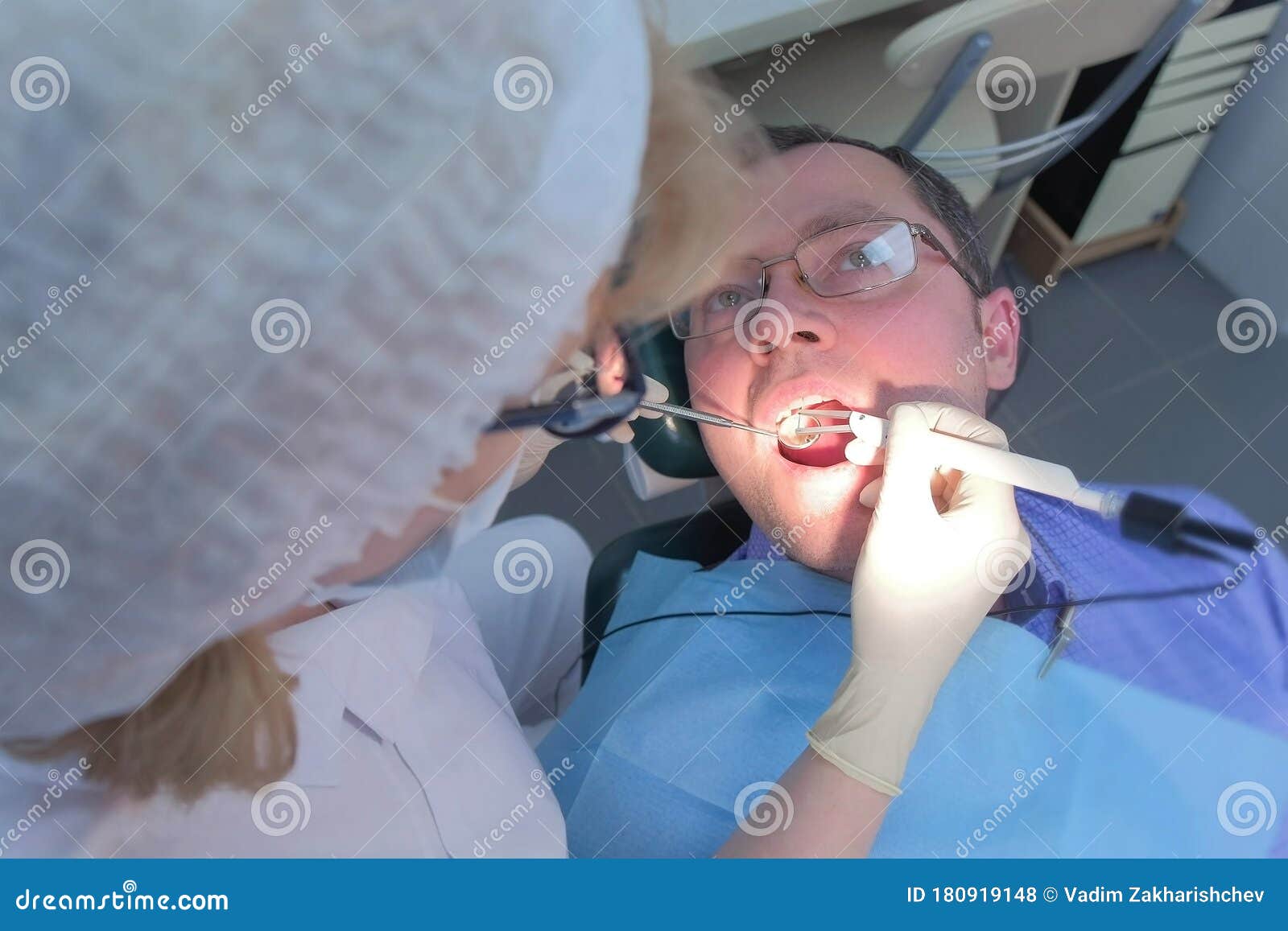 Dentist Examining Patient Gums with Probe Using Method of Computer ...
