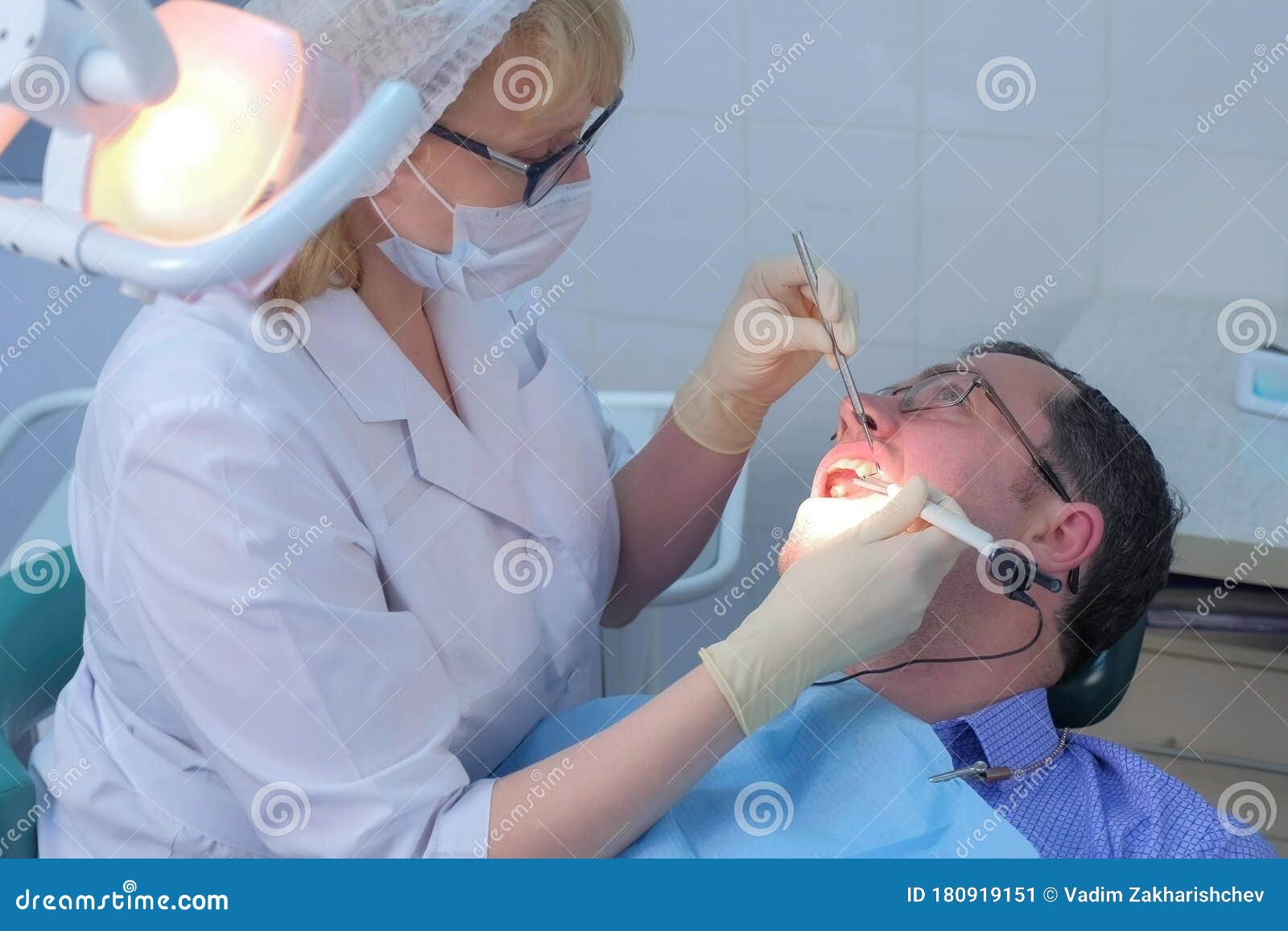 Dentist Examining Patient Gums with Probe Using Method of Computer ...