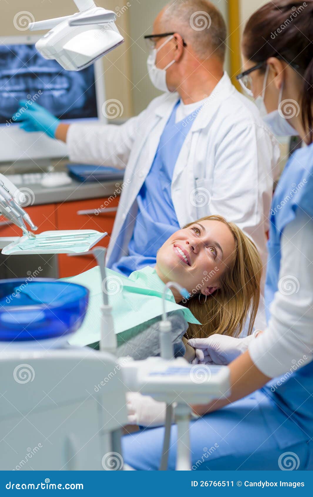 The Dentist And Her Happy Patient Look At The Camera And Smile ...