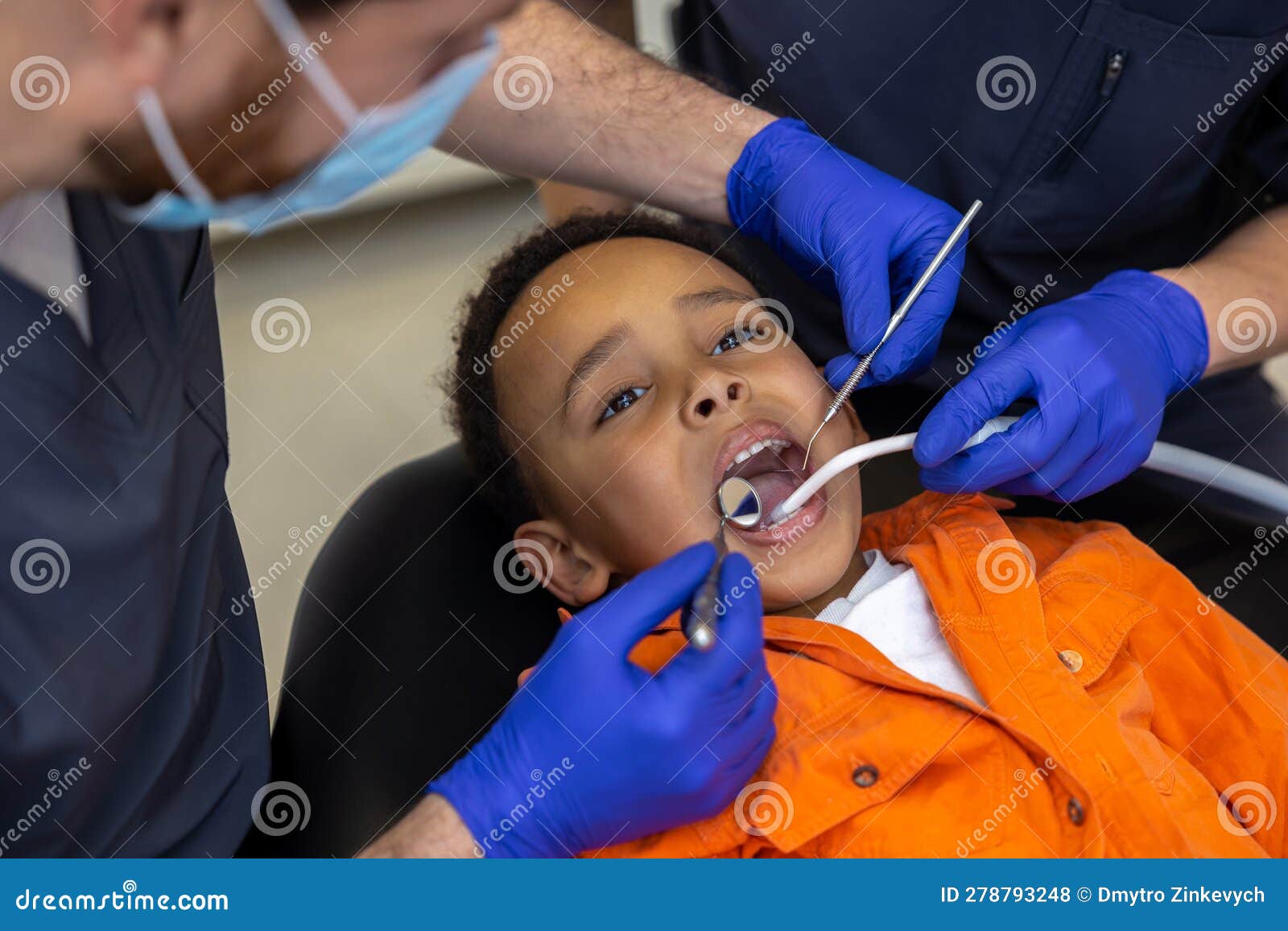 Dentist and His Assistant Treating Boys Teeth Stock Photo - Image of ...