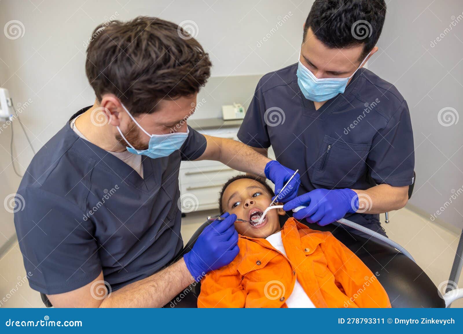 Dentist and His Assistant Working with a Dark-skinned Boy Stock Image ...