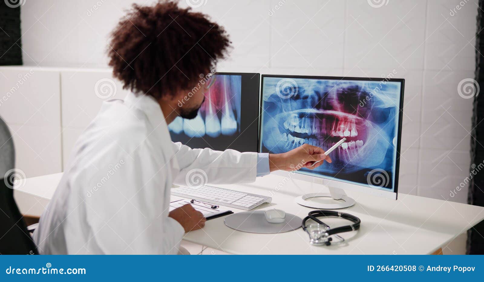Dentist Looking at Teeth Xray Scan Stock Photo - Image of black, side ...
