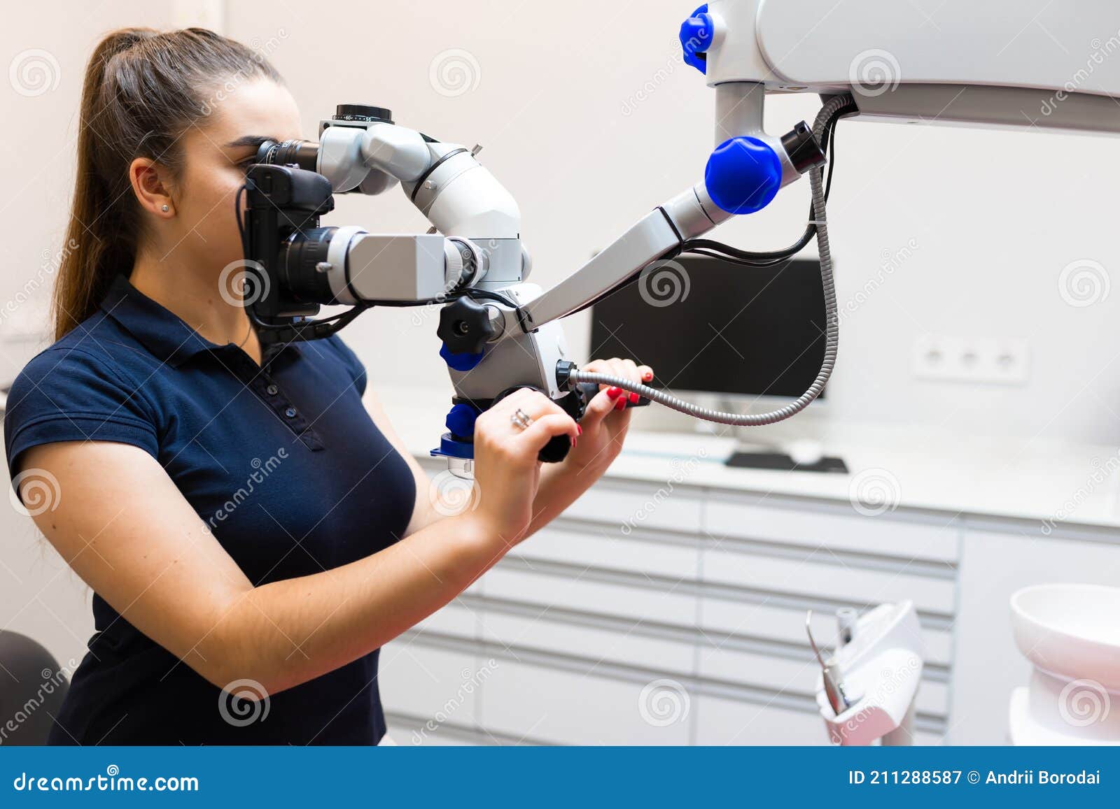 Dentist Looks through the Microscope. Modern Dental Equipment. Stock ...
