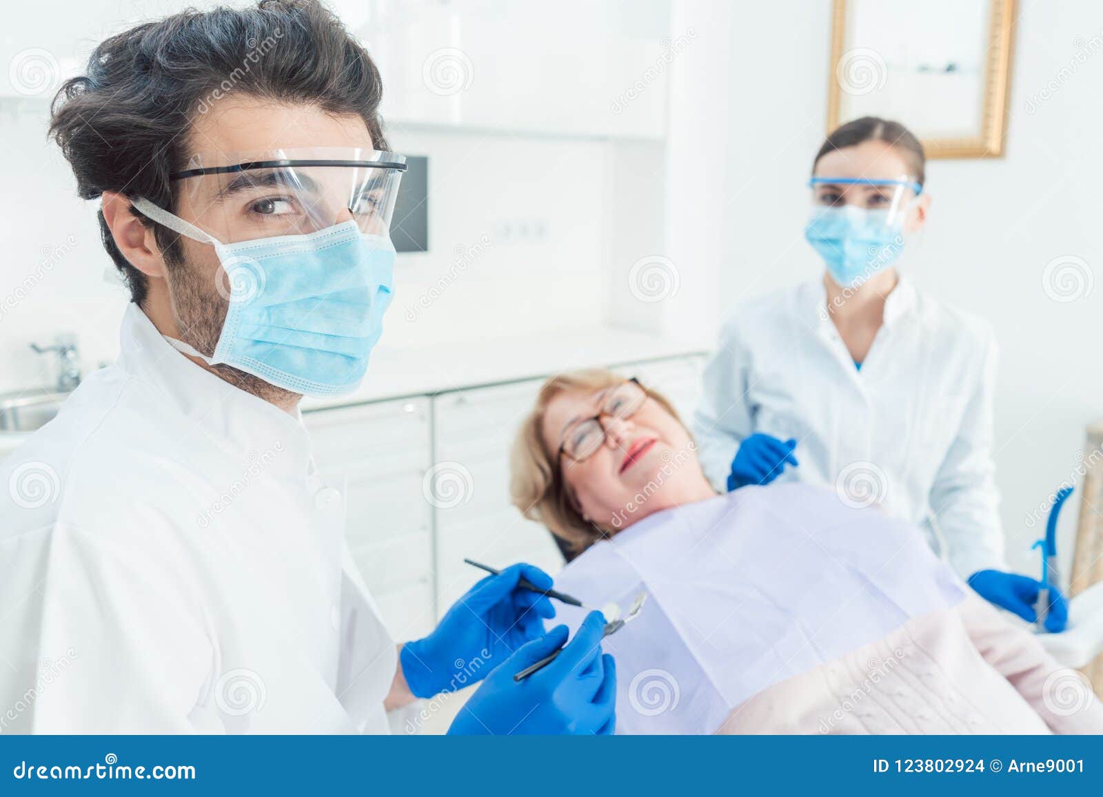 Dentist man in his surgery stock photo. Image of shield - 123802924