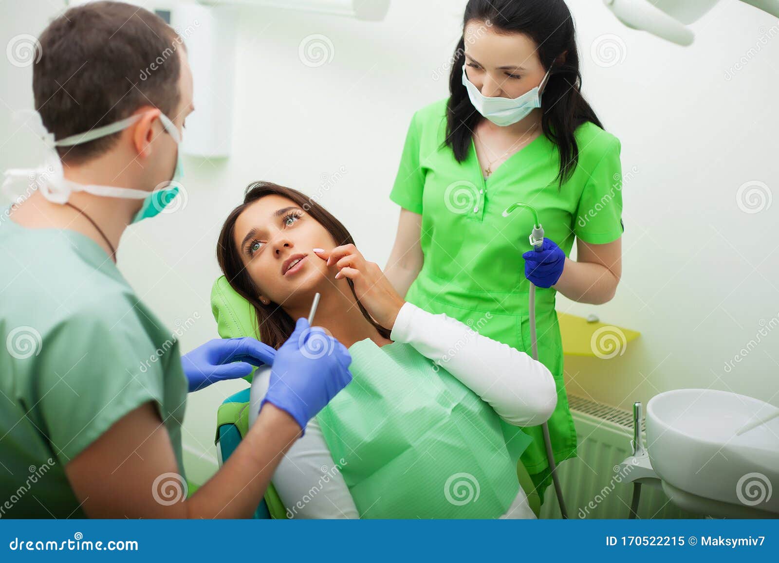 The Dentist Man are Treating Teeth To Client in Dental Office Stock ...