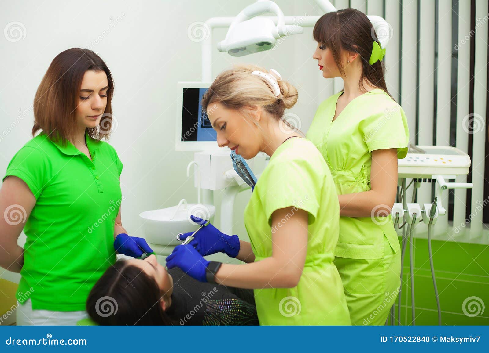 The Dentist Man are Treating Teeth To Client in Dental Office Stock ...