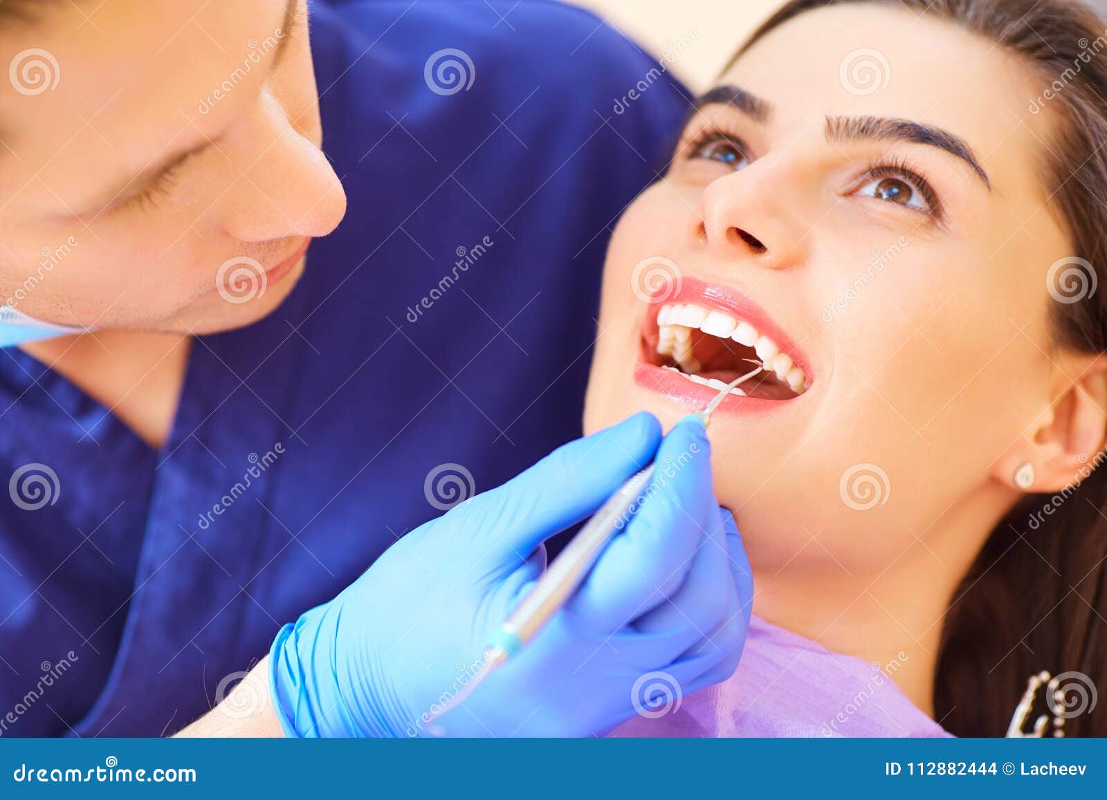 The Dentist Man are Treating Teeth To Client in Dental Office Stock ...