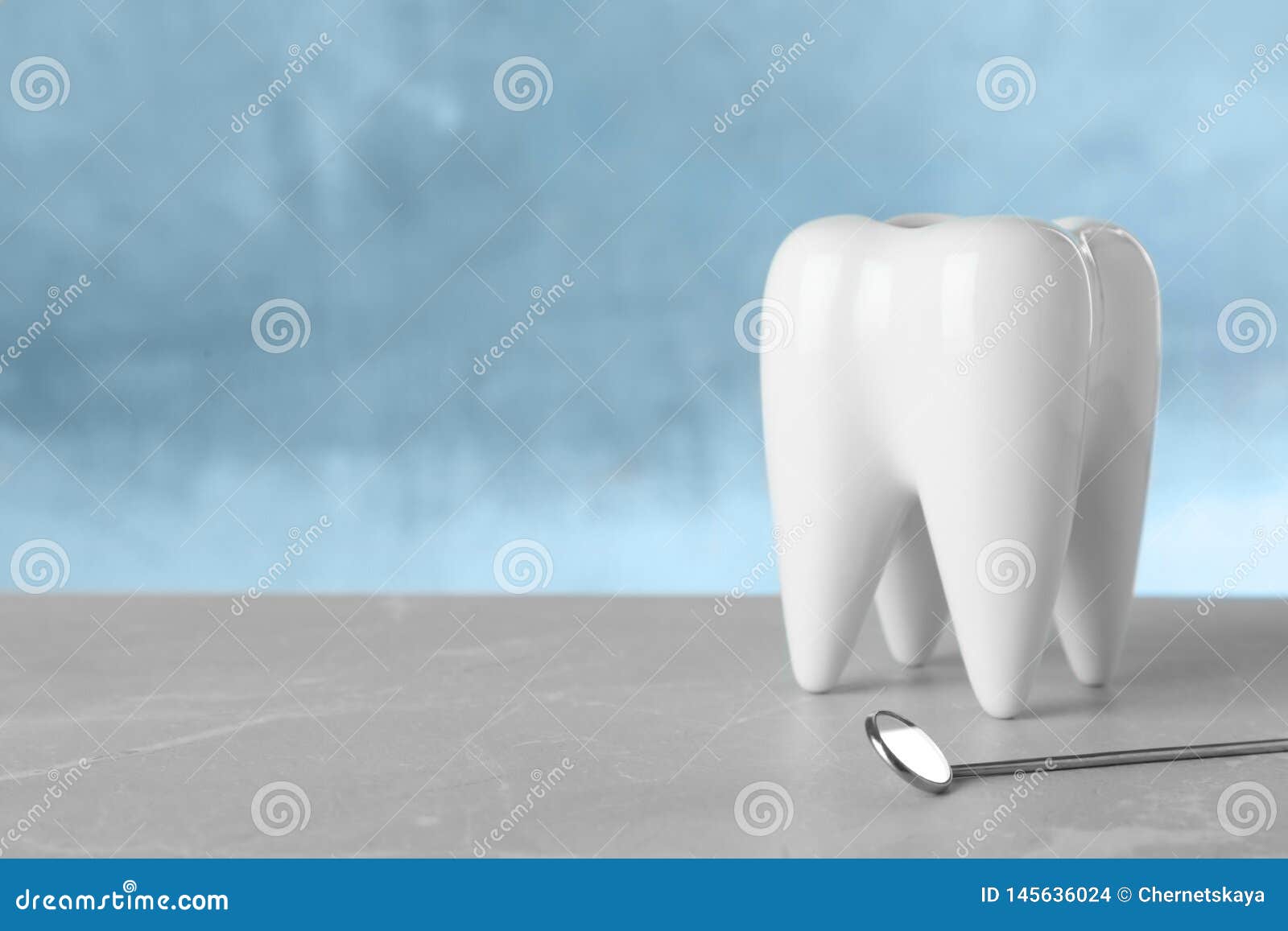 Dentist Mirror and Tooth Shaped Holder on Table Stock Photo - Image of ...