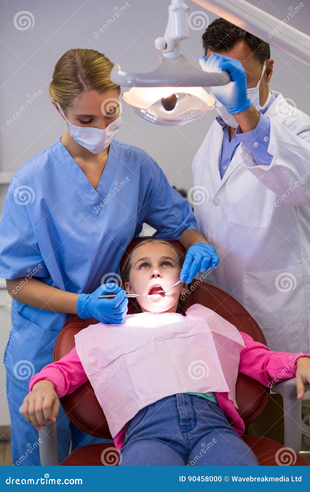 Dentist and Nurse Examining a Young Patient with Tools Stock Photo ... Dentist and Nurse Examining a Young Patient with Tools Stock Photo ...