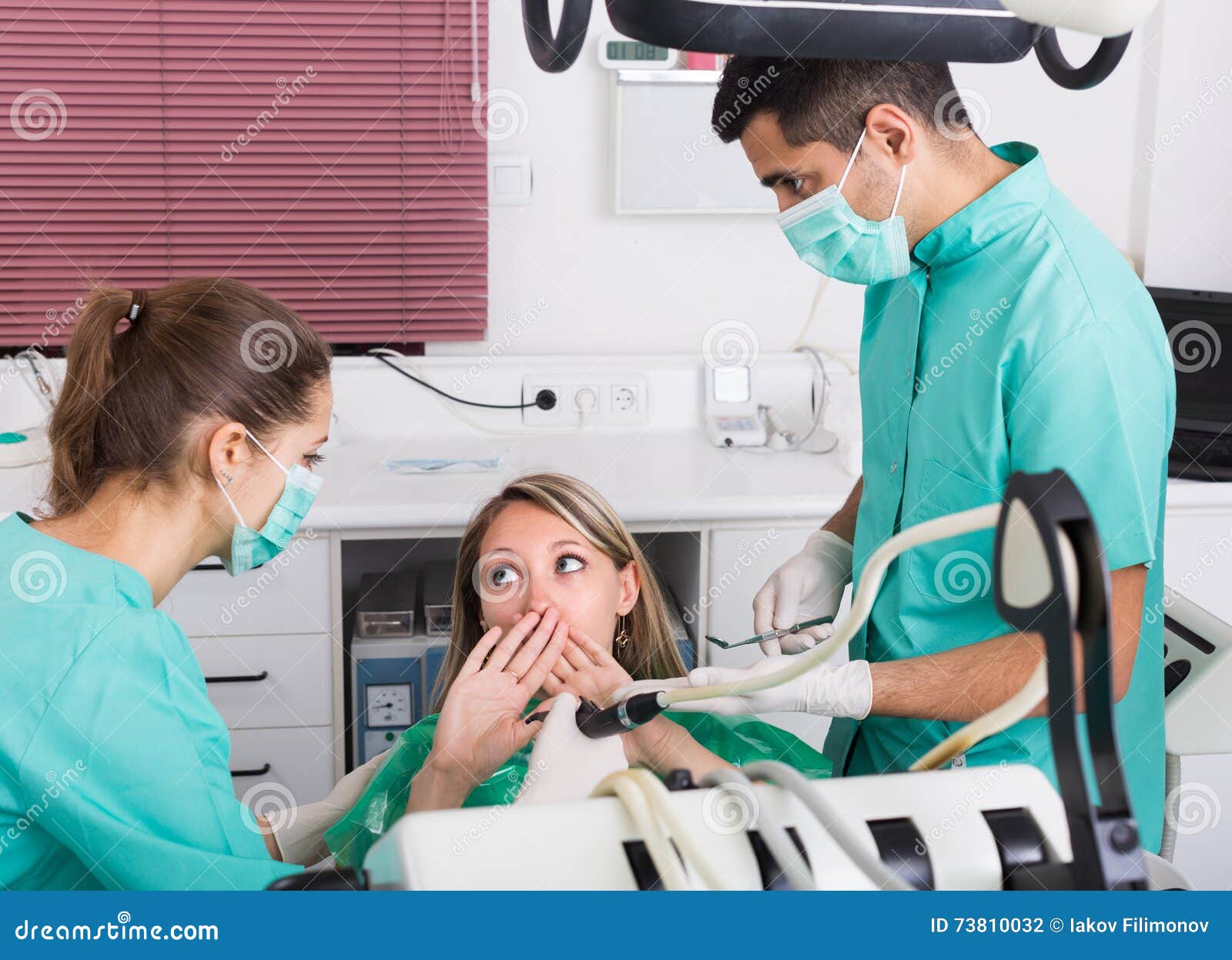 Dentist and scared patient stock photo. Image of pain - 73810032