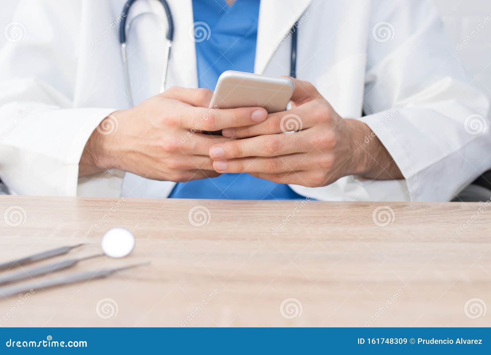 Dentist with smartphone stock image. Image of beauty - 161748309