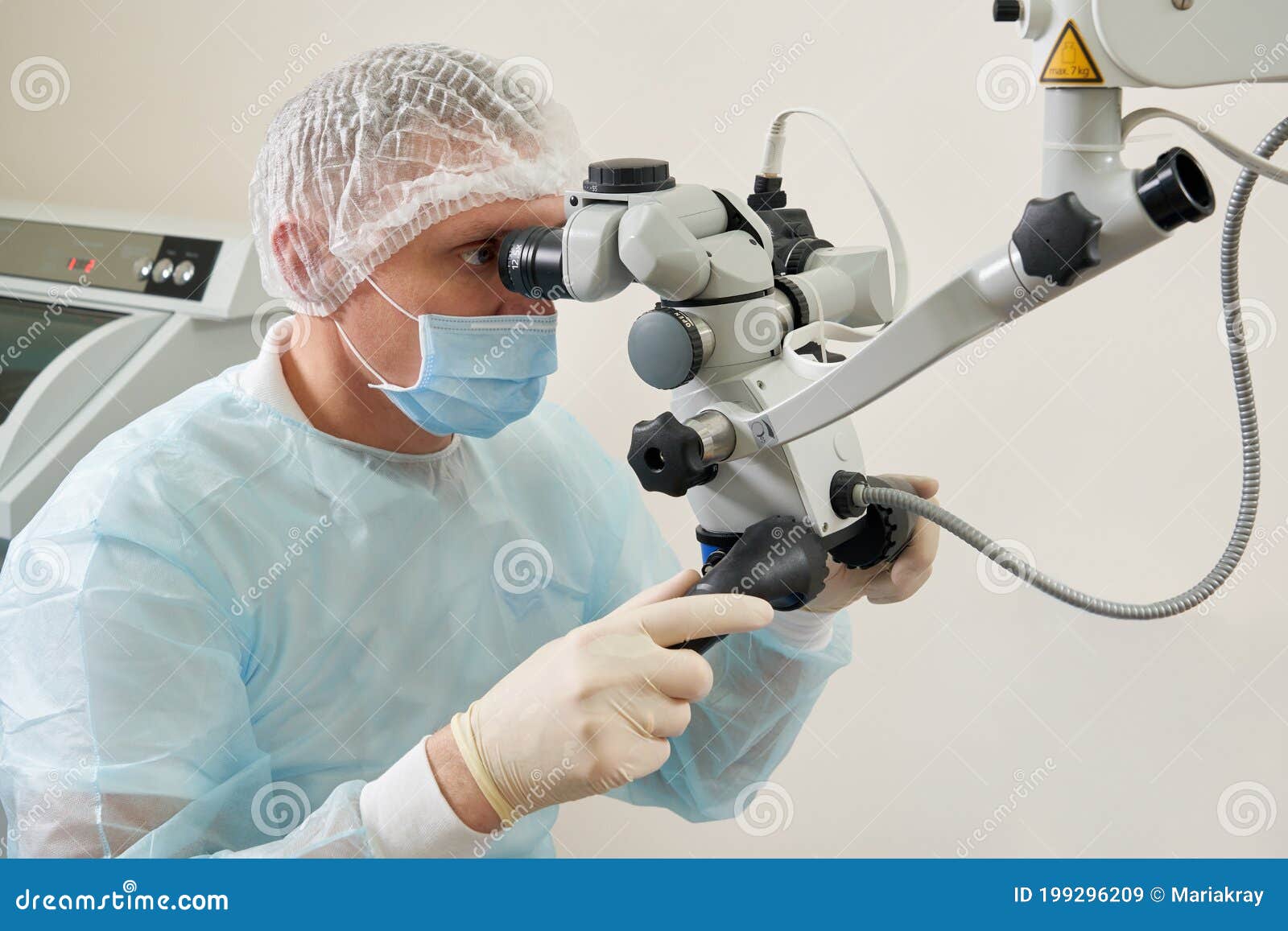 Dentist Working with Dental Microscope and Patient at Modern Dentist ...