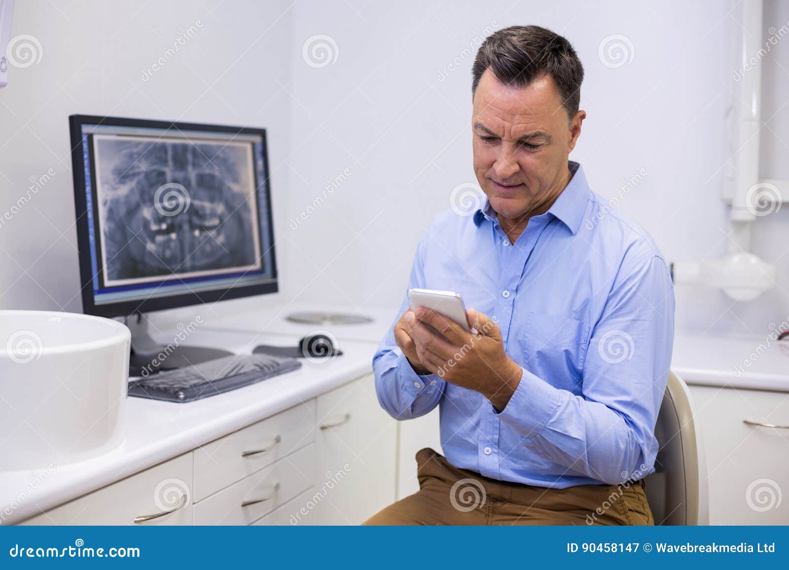 Dentist using mobile phone stock image. Image of formal - 90458147