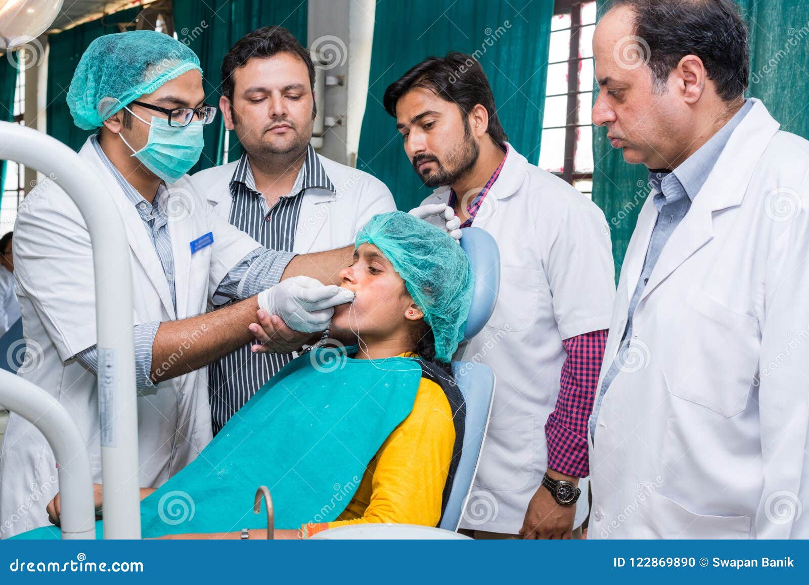 Dentist at work editorial image. Image of patient, assistant - 122869890