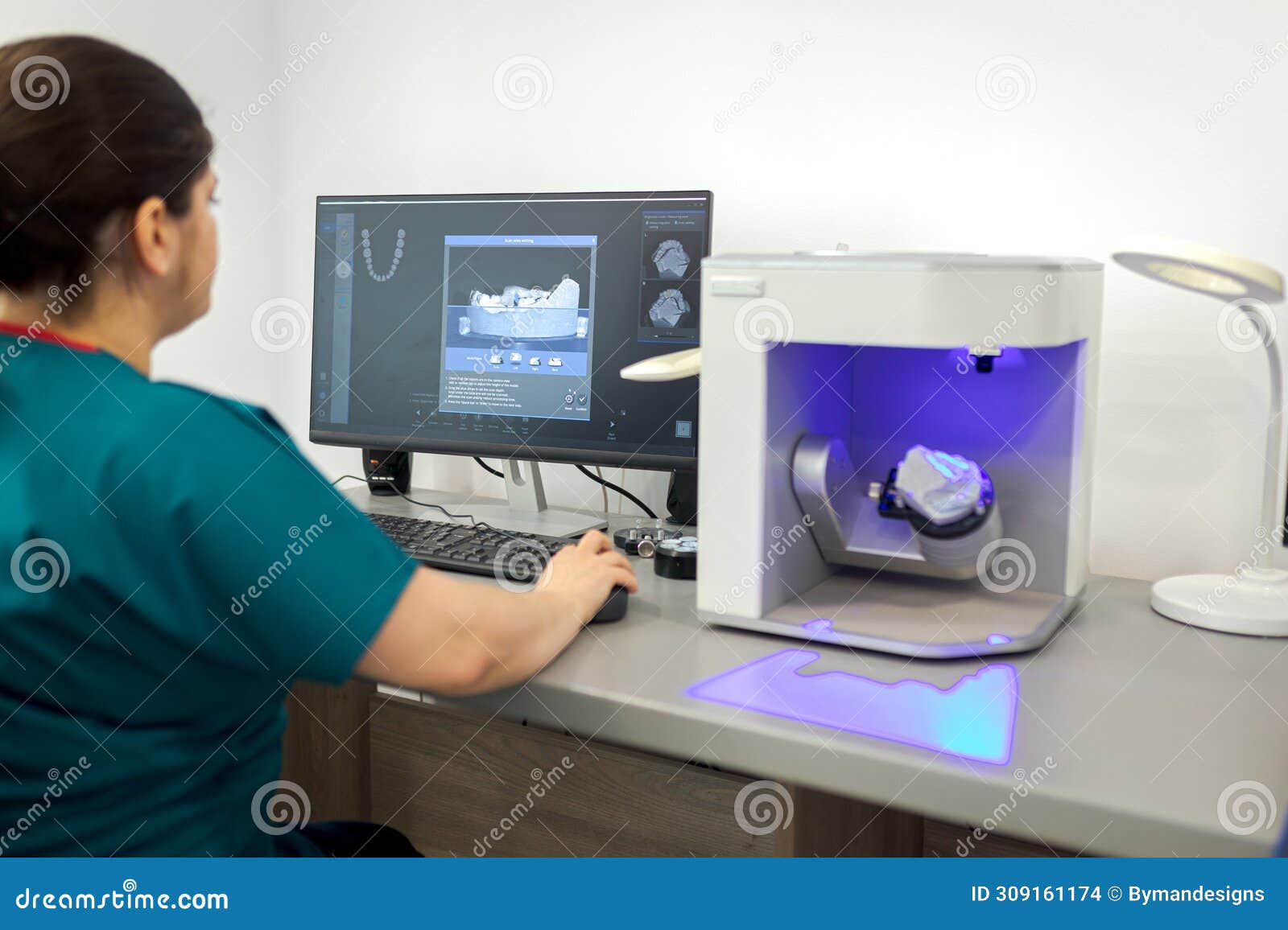 Dentist Working on Computer with a Dental Scan Software for Make Dental ...