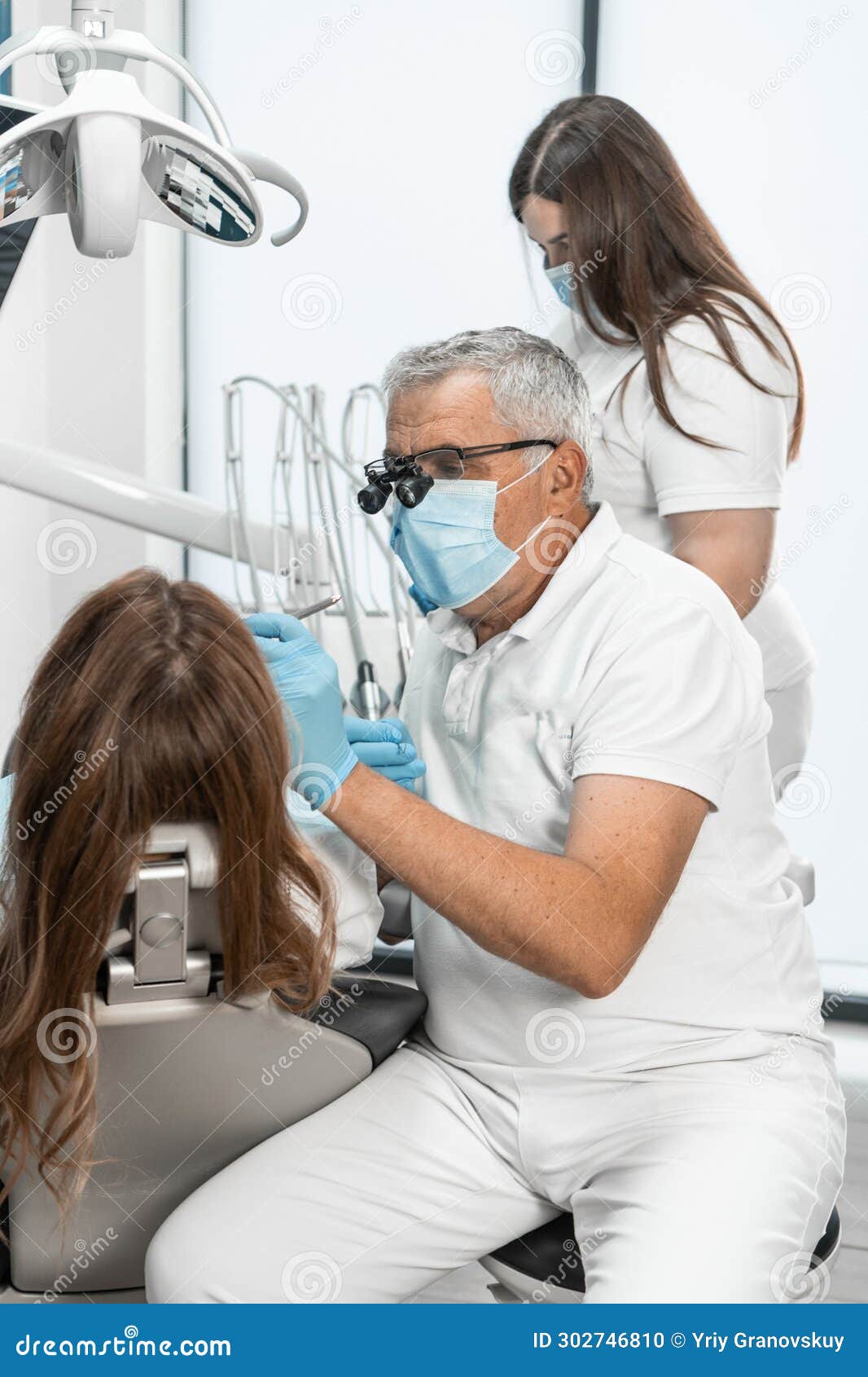 The Dentist Works in a Modern and Bright Clinic, Creating a Pleasant ...