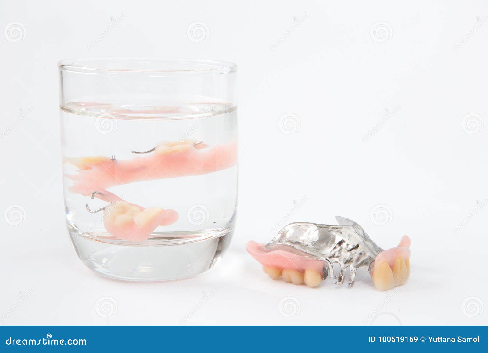 Denture Is Cleaned In A Glass Of Water. Proper Hygiene. Stock Photo ...