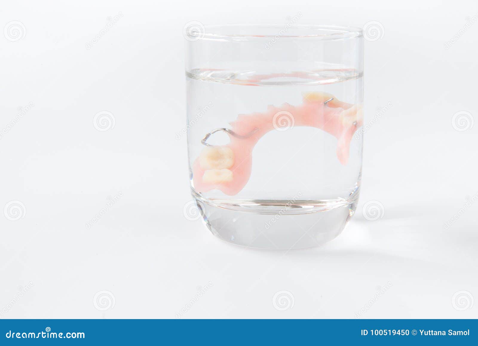 Denture Is Cleaned In A Glass Of Water. Proper Hygiene. Stock Photo ...