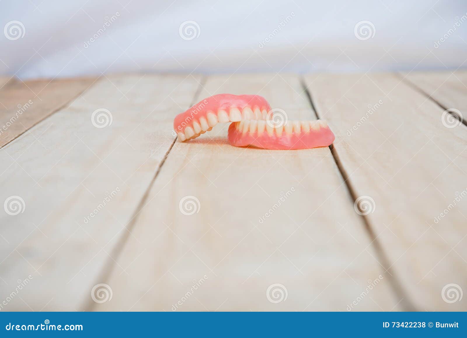 Dentures on wooden table stock photo. Image of human - 73422238