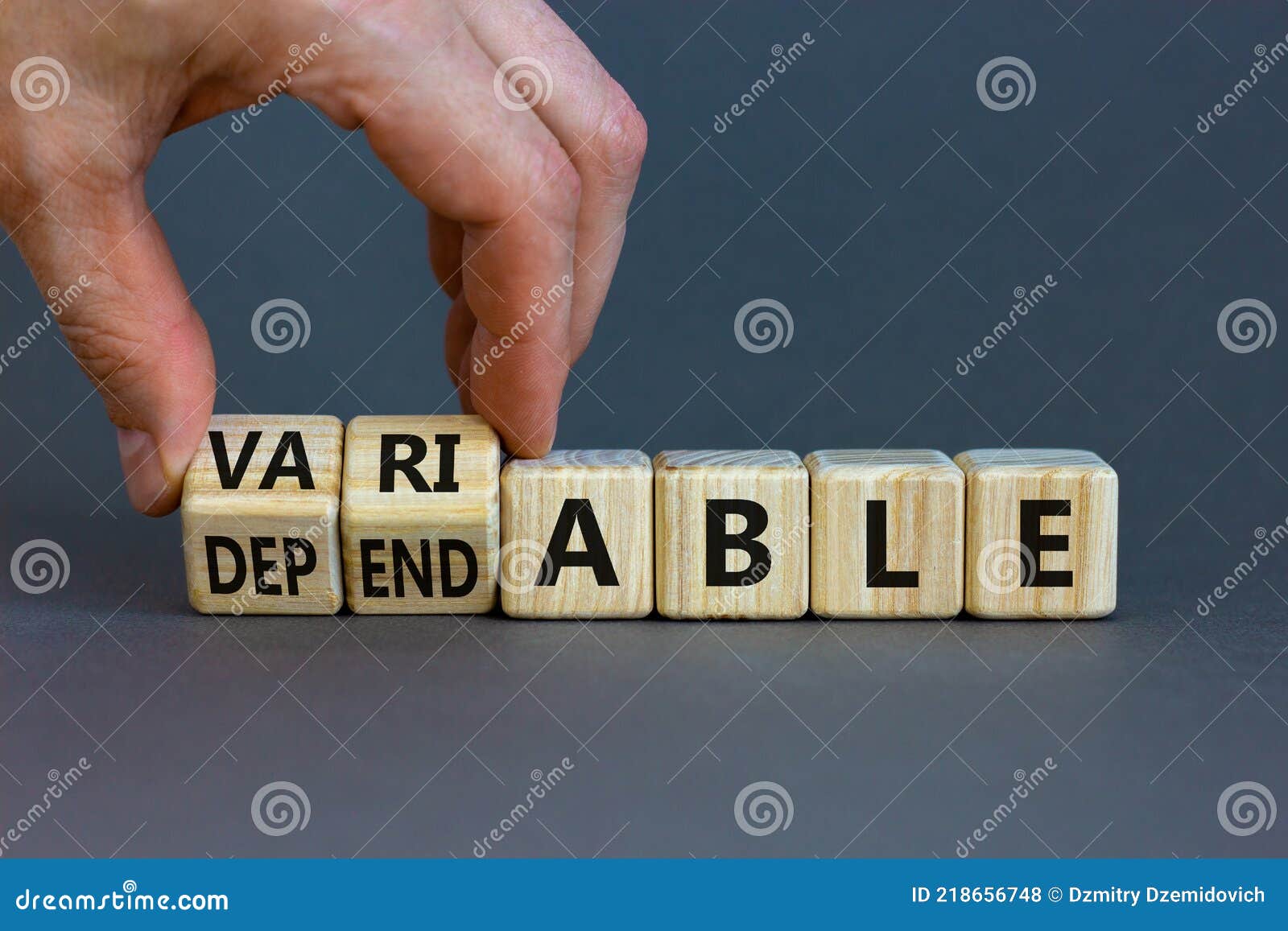 Dependable or Variable Symbol. Businessman Turns Wooden Cubes and ...