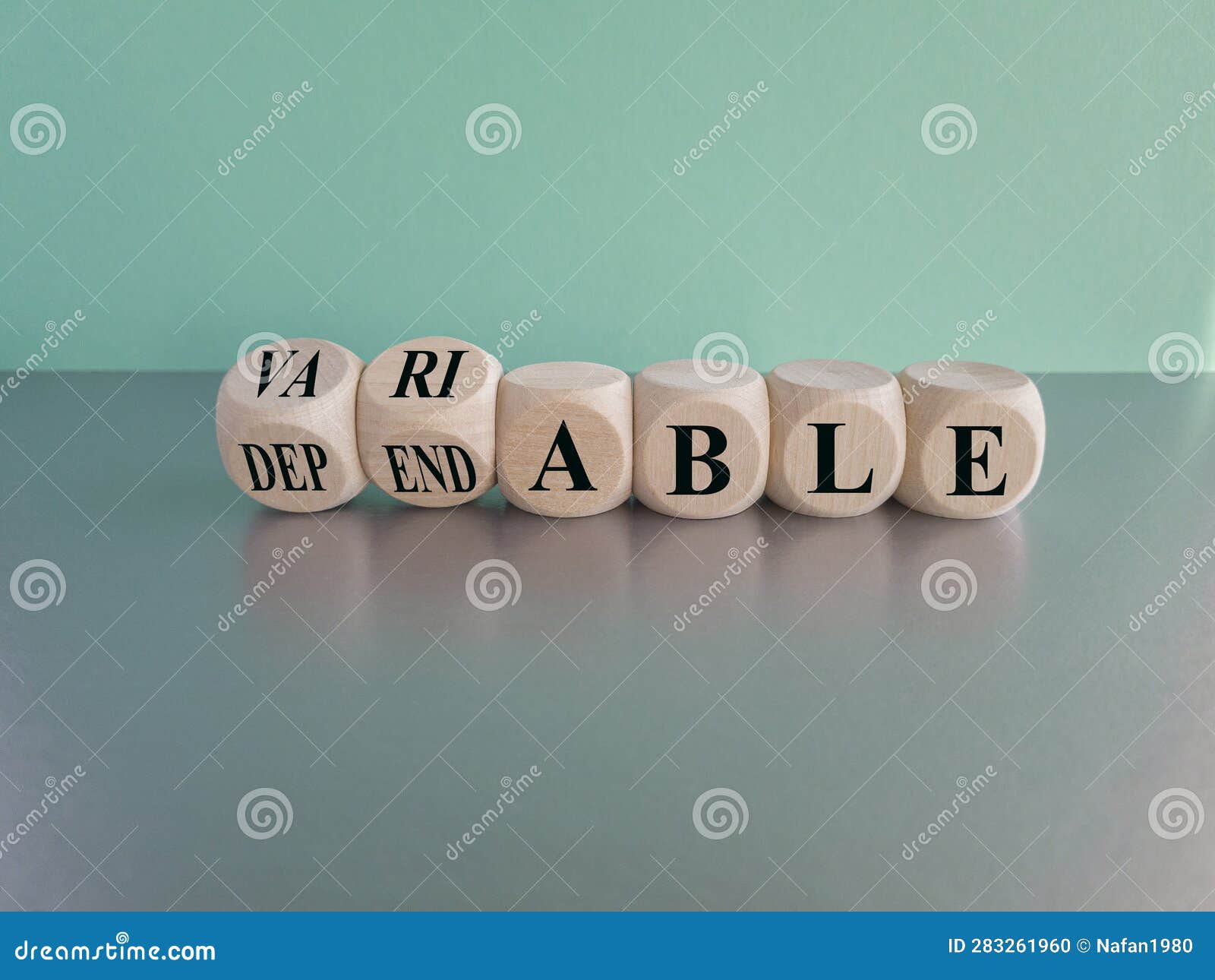 Dependable or Variable Symbol. Turned Wooden Cubes and Changes the Word ...