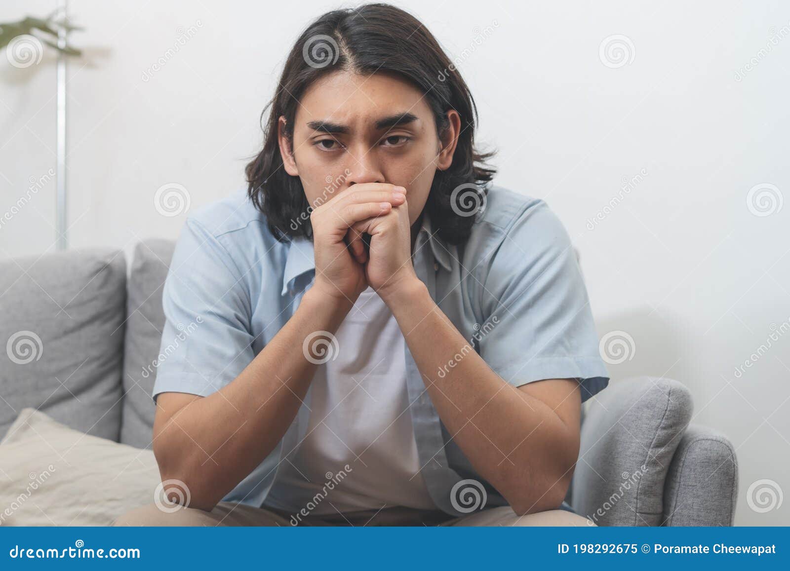 Depressed Asian Man Sitting on the Sofa Regret about His Fault Stock ...