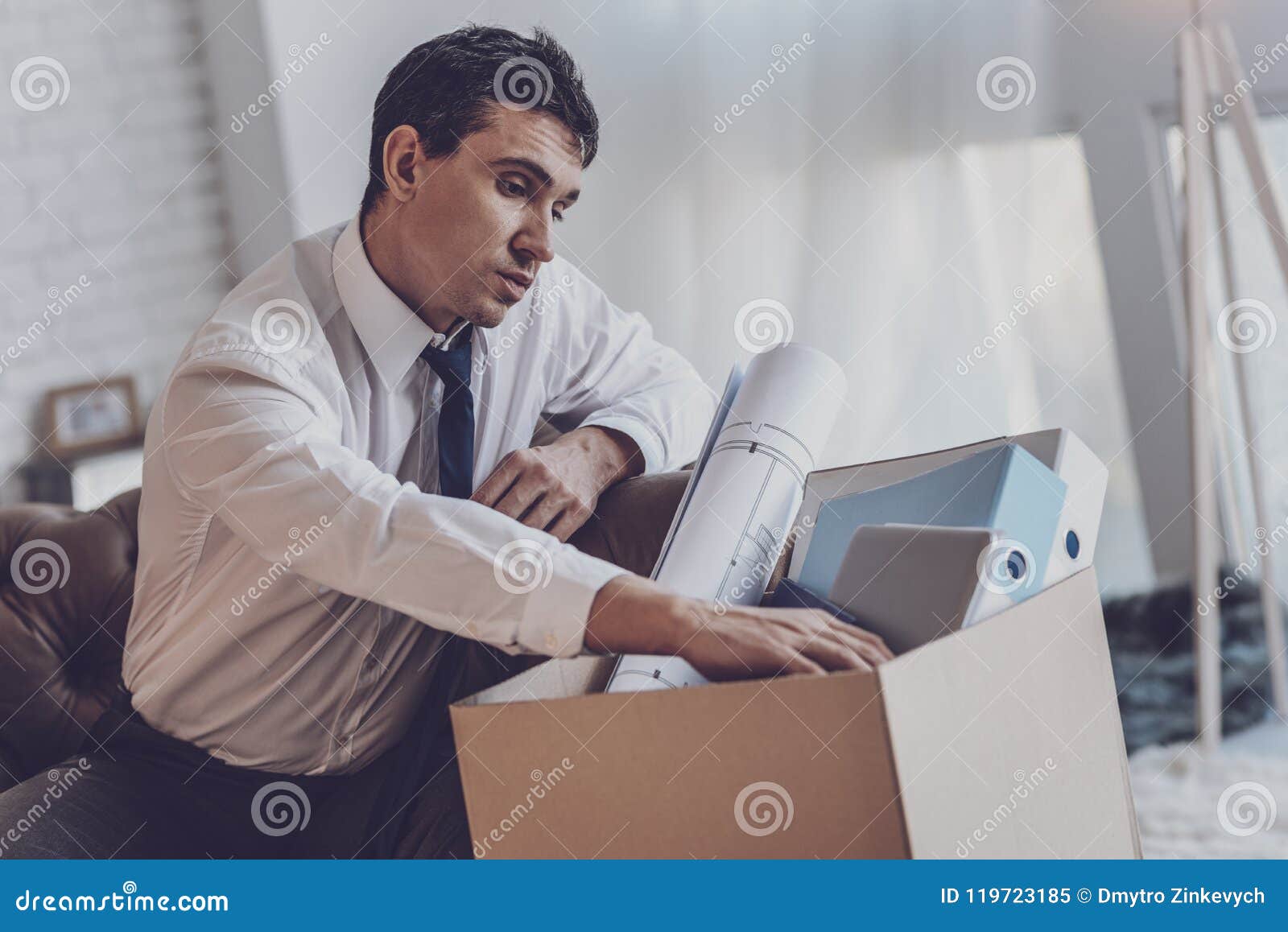 Fired Depressed Male Office Worker With Box Of Personal Stuff Walking ...