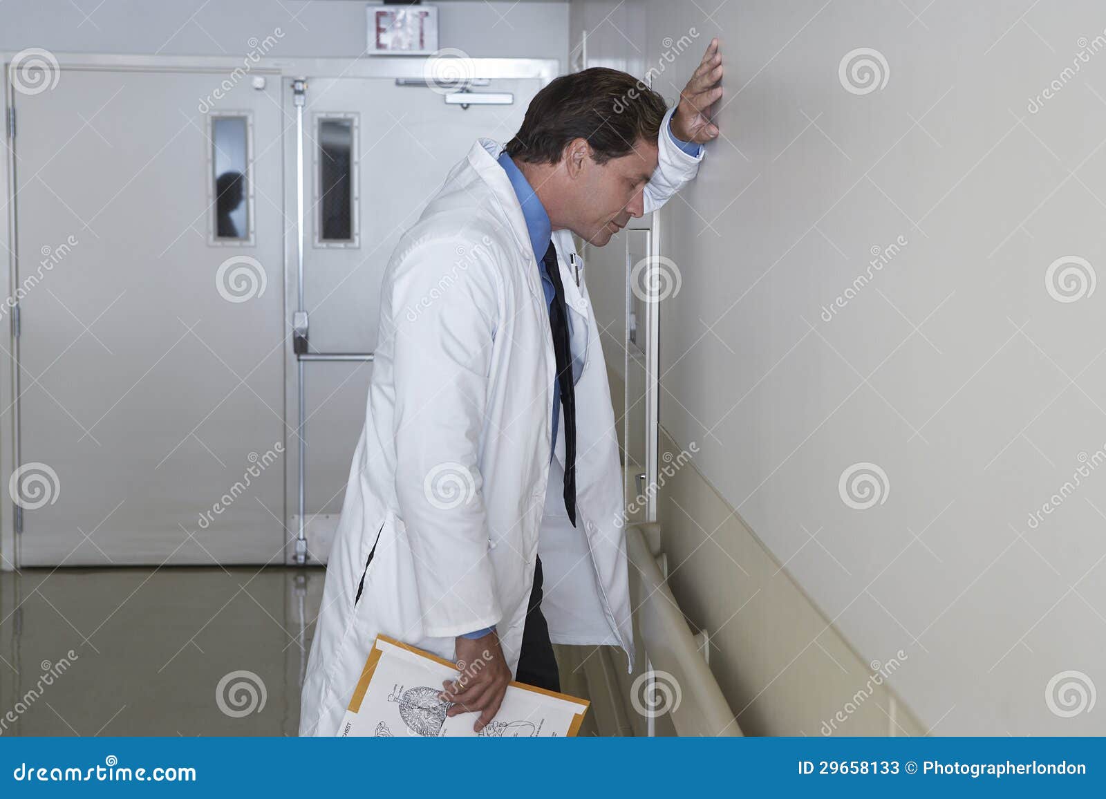 Depressed Doctor Leaning Against Wall Stock Image - Image of indoors ...