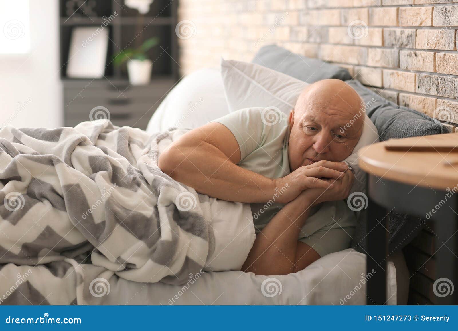 Depressed Elderly Man Lying on Bed at Home Stock Image - Image of ...