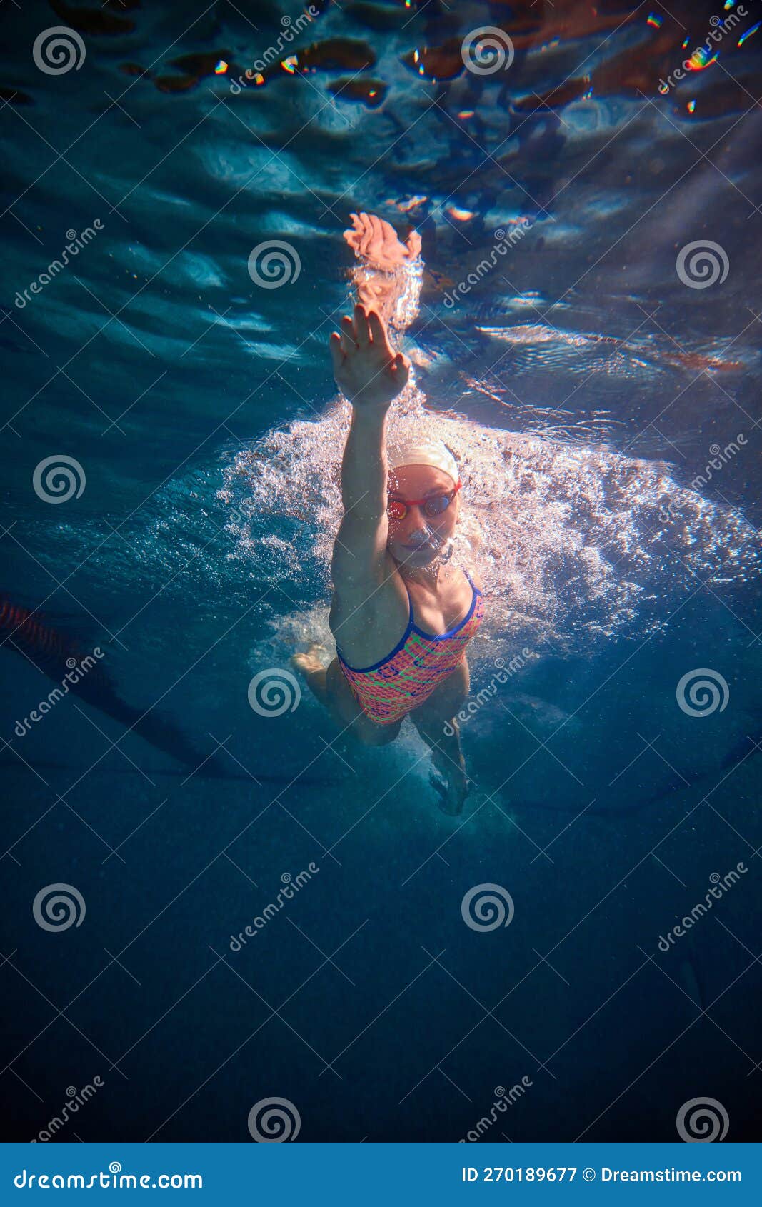 Depth. Dynamic Shot of Professional Female Swimmer Training in Swimming ...