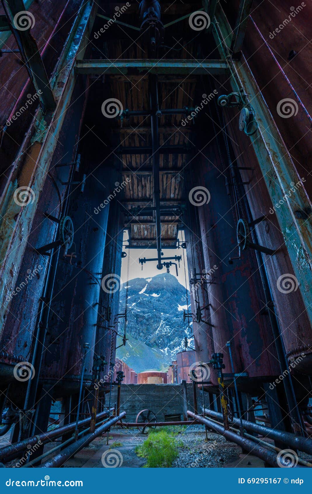 Derelict Factory with Rusty Pipes and Grass Stock Image - Image of high ...