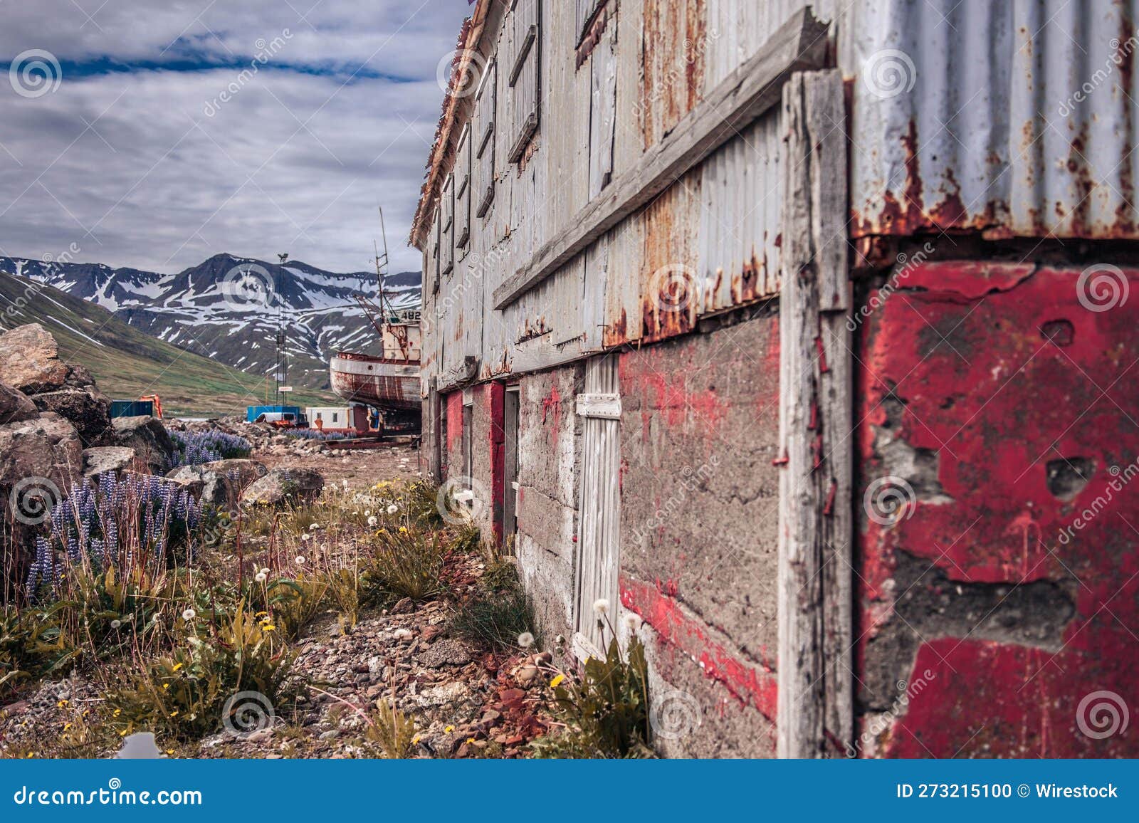 Derelict Metal Structure Featuring Rust and Broken Doors, Nestled in a ...