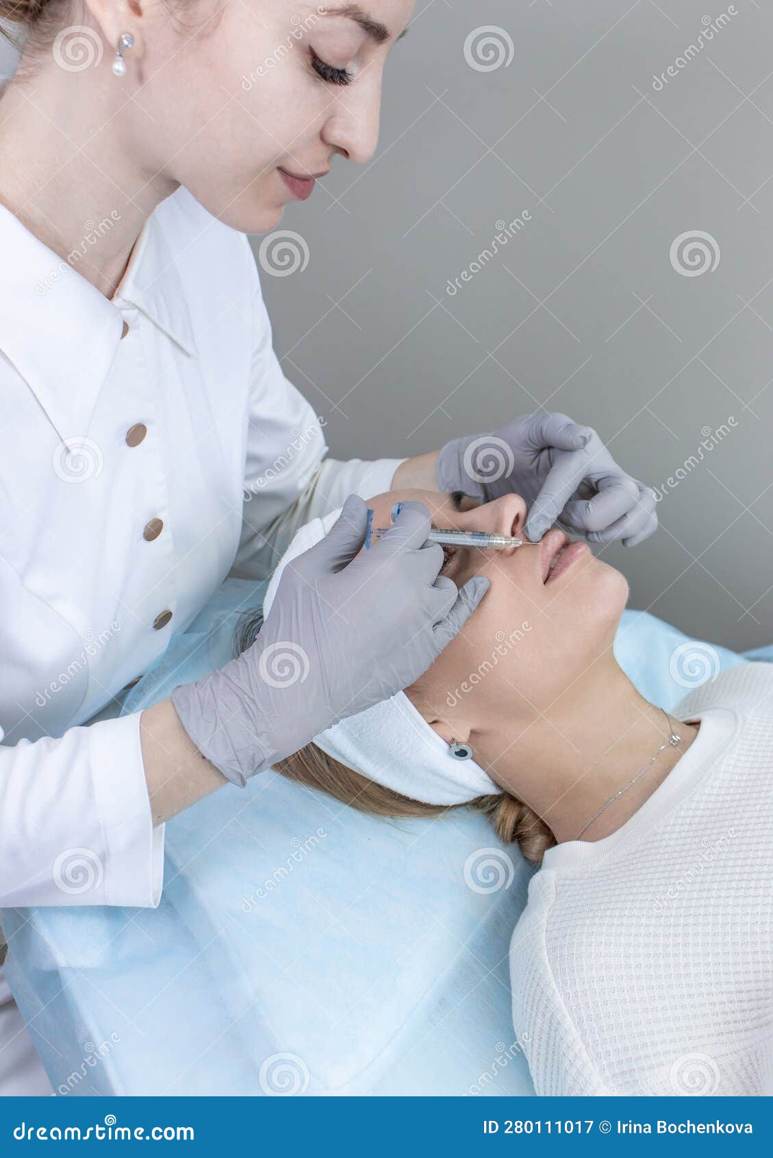 A Dermatologist Cleanses The Skin On A Young Womanand X27 S Face With An