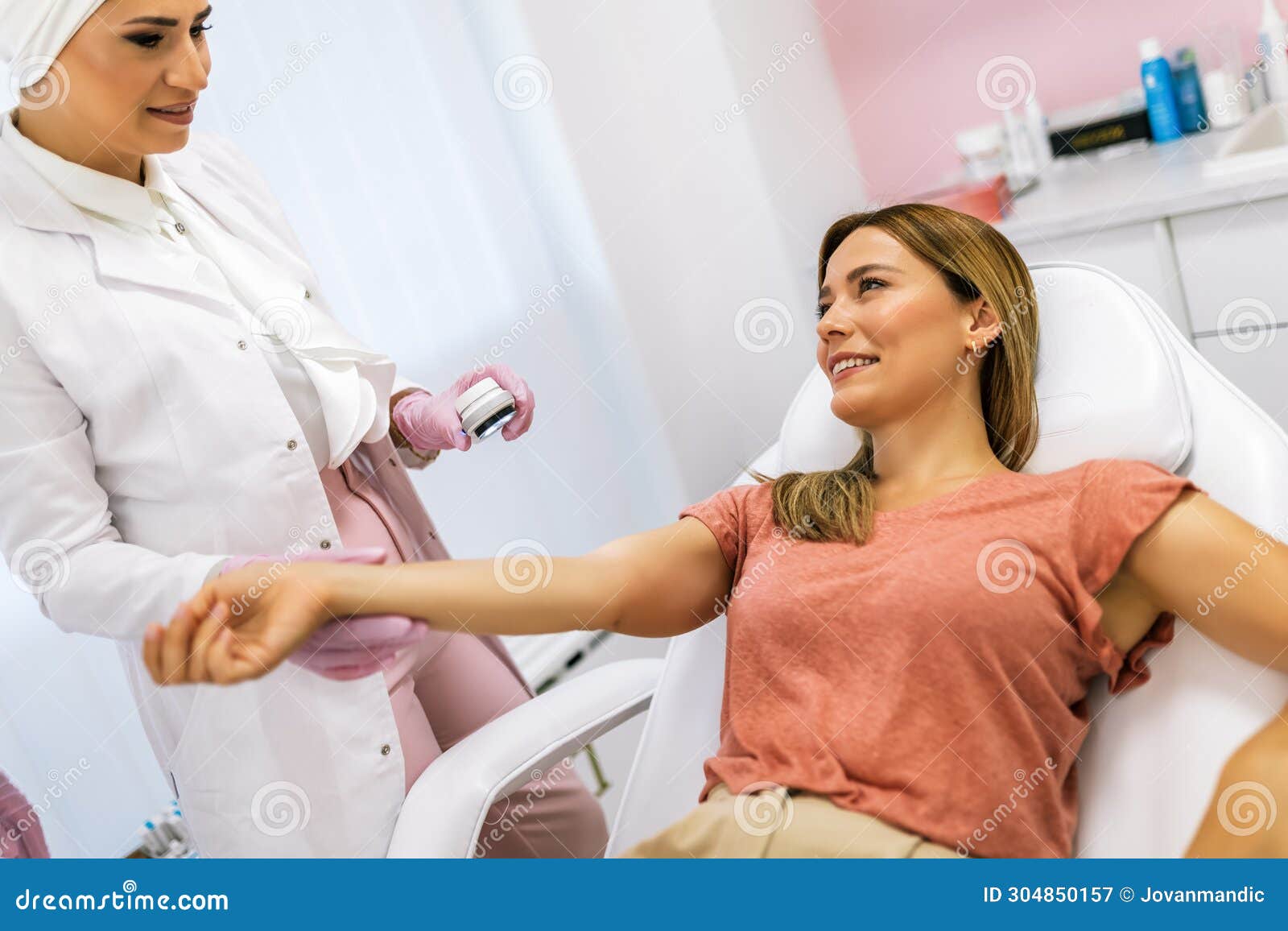 Dermatologist Examines The Moles Or Acne Of The Patient With A