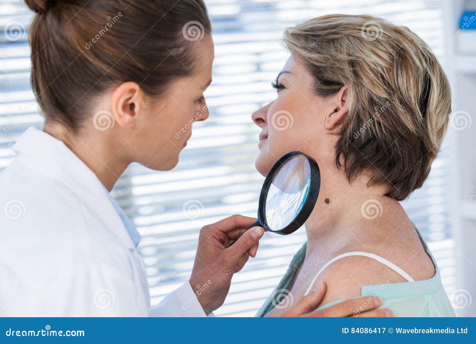 Dermatologist Examining Mole with Magnifying Glass Stock Image - Image ...