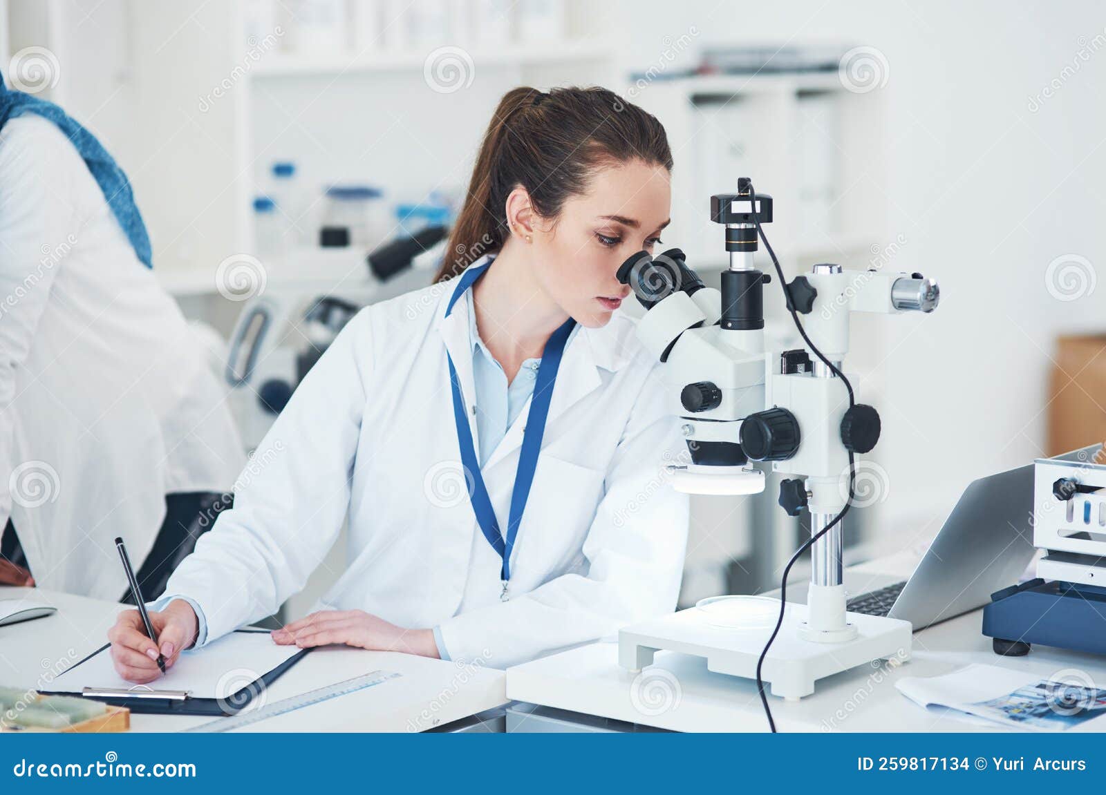 Describing on Paper What she Sees. a Focused Young Female Scientist ...