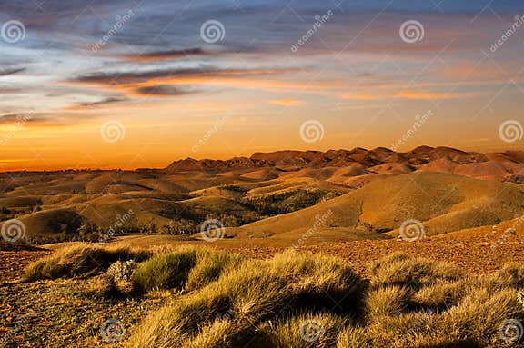 Desert land sunset stock image. Image of bush, hill, ochre - 16375169